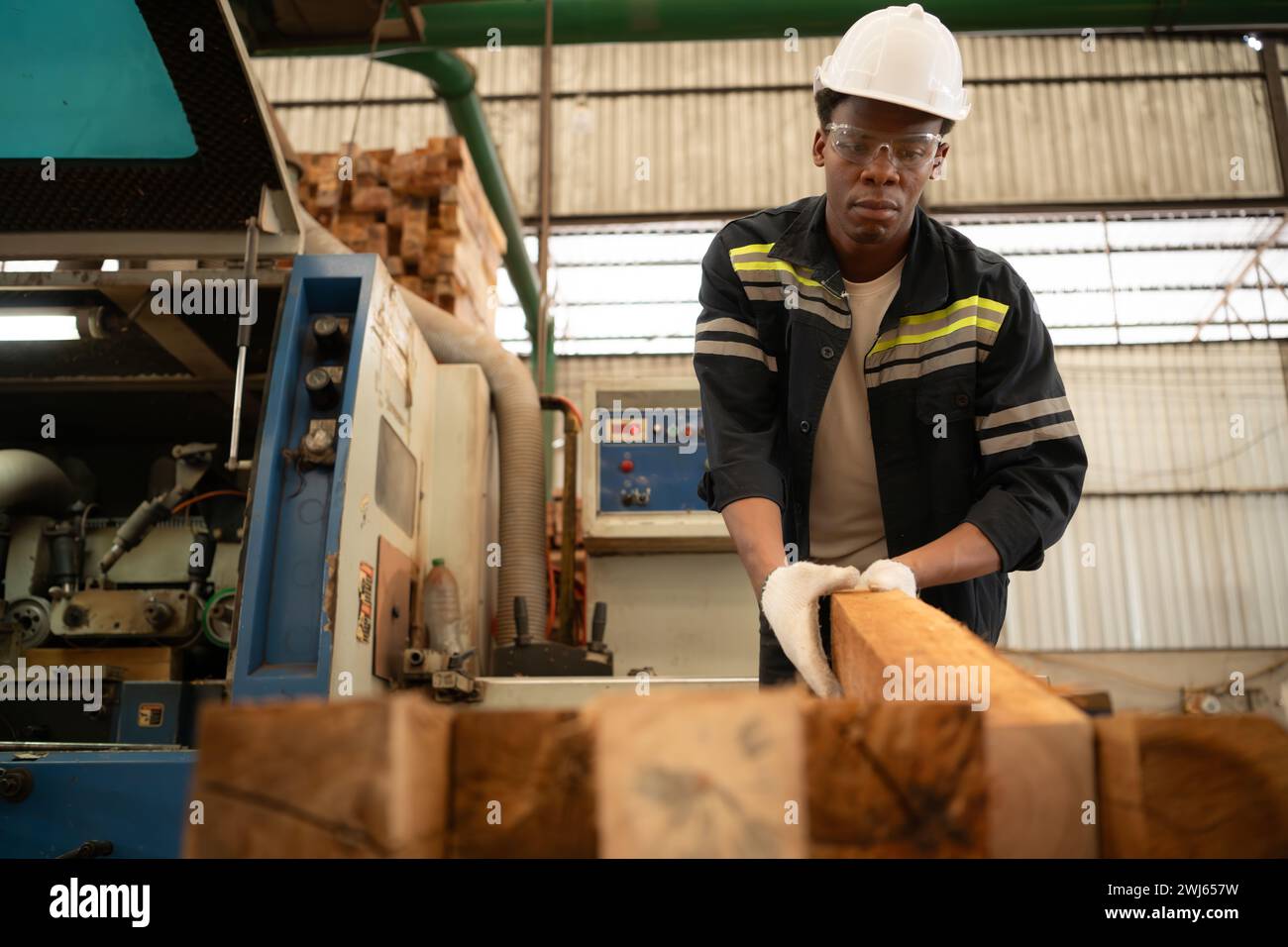 Young man worker work in a woodworking factory, Working with wood ...