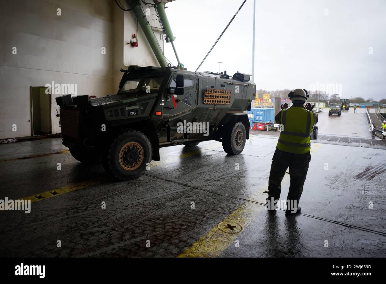 Vehicles and equipment are loaded onboard MV Anvil Point at the Sea ...