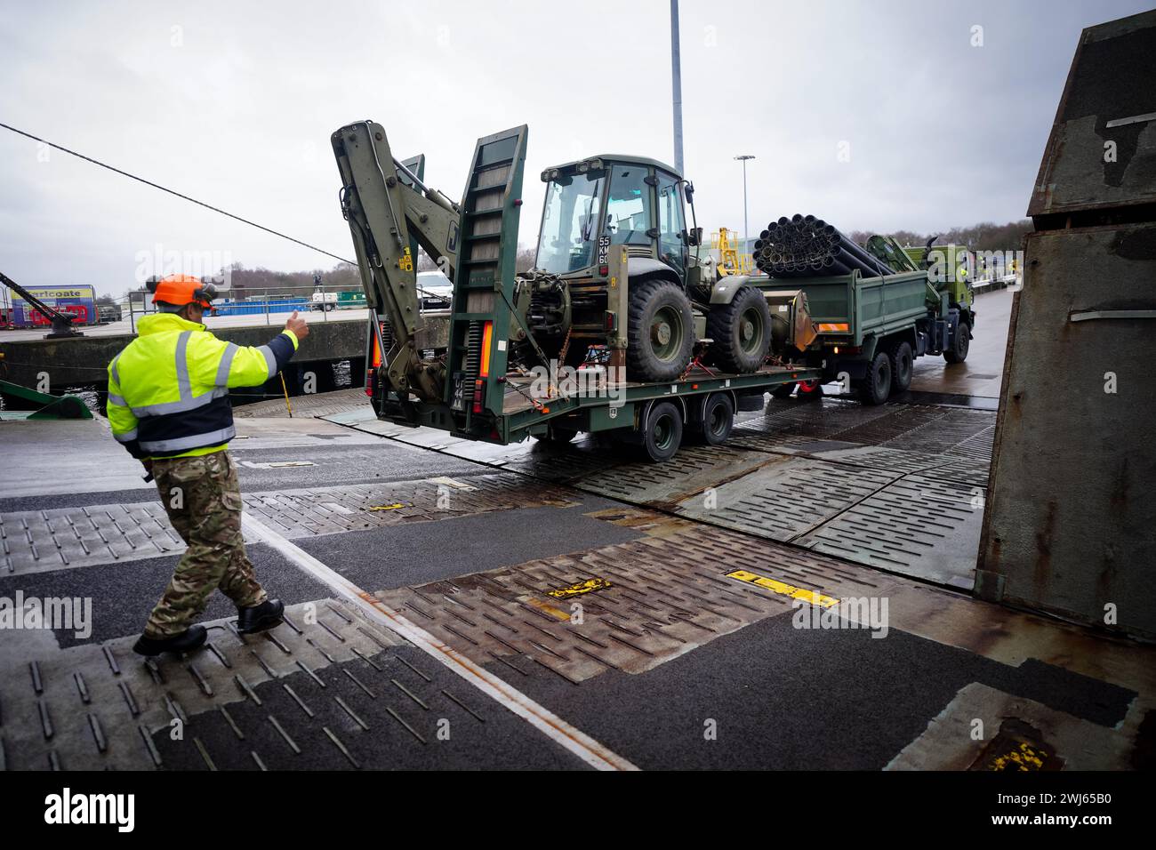 Vehicles and equipment are loaded onboard MV Anvil Point at the Sea ...
