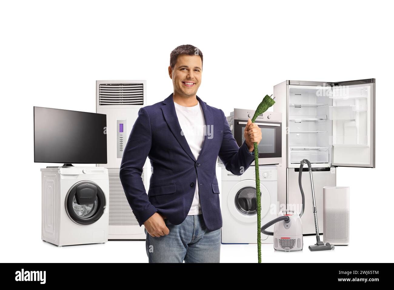 Happy young man with a green cable in front of electric appliances ...