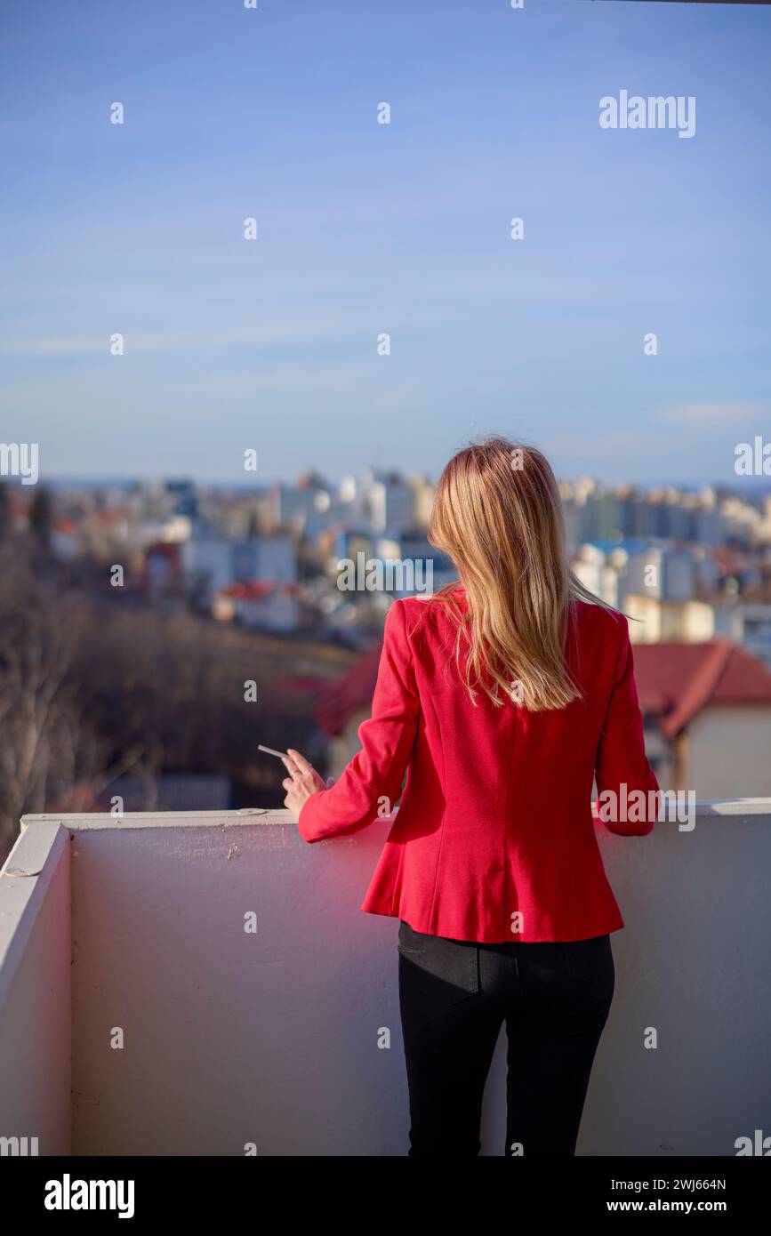 Woman smoking on balcony hi-res stock photography and images - Alamy