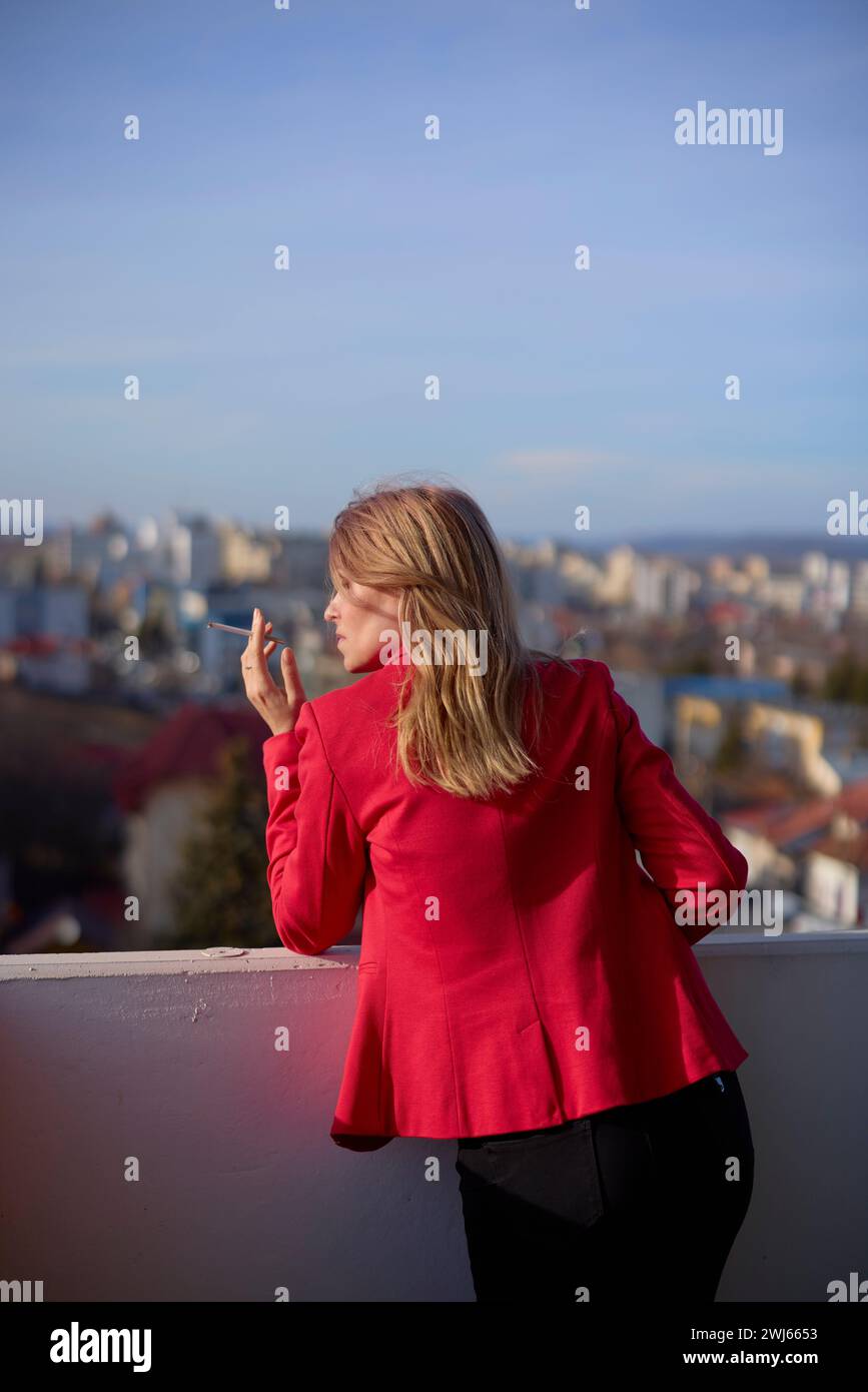 Woman smoking cigarette balcony hi-res stock photography and images - Alamy