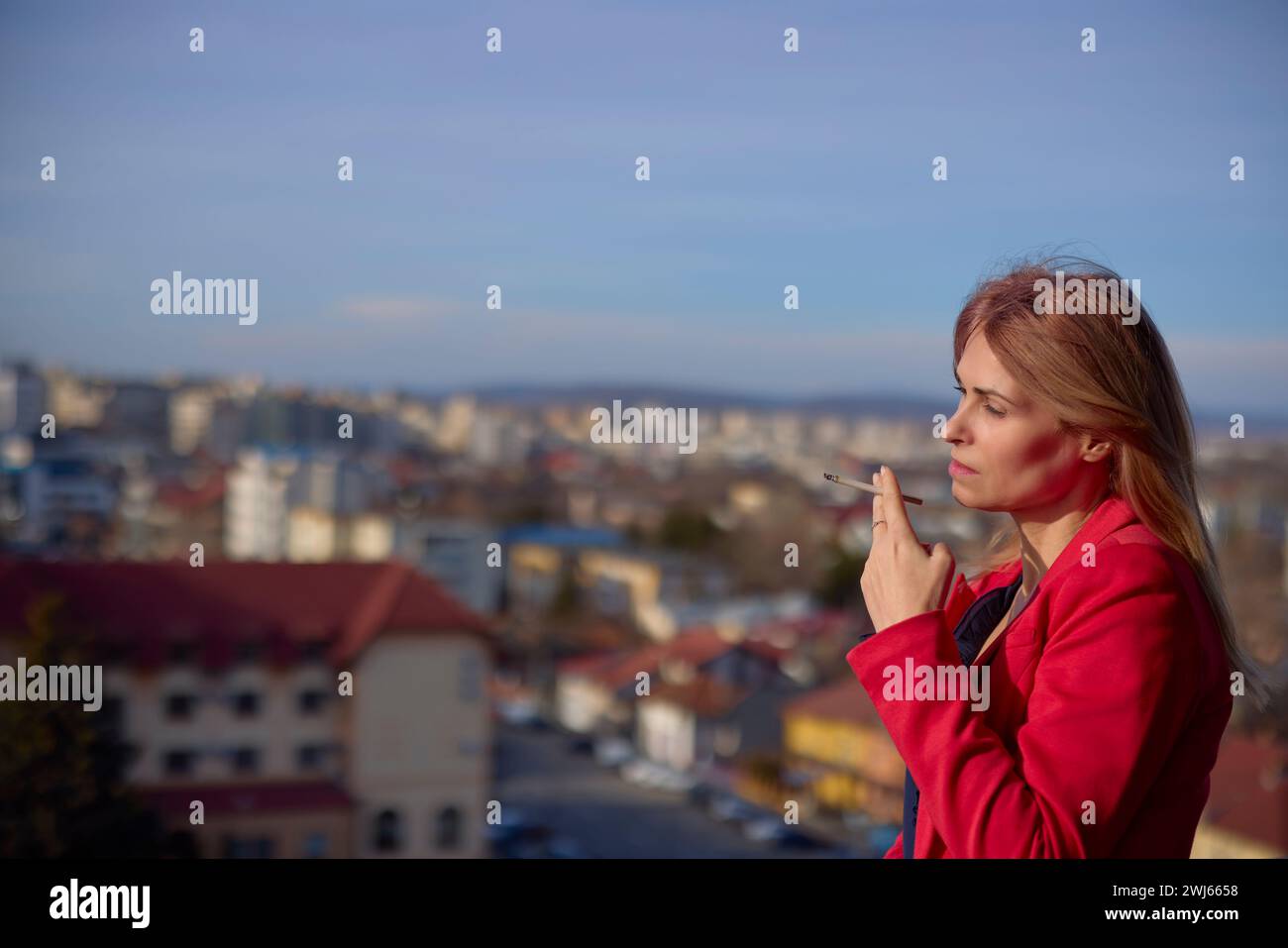 Woman smoking on balcony hi-res stock photography and images - Alamy
