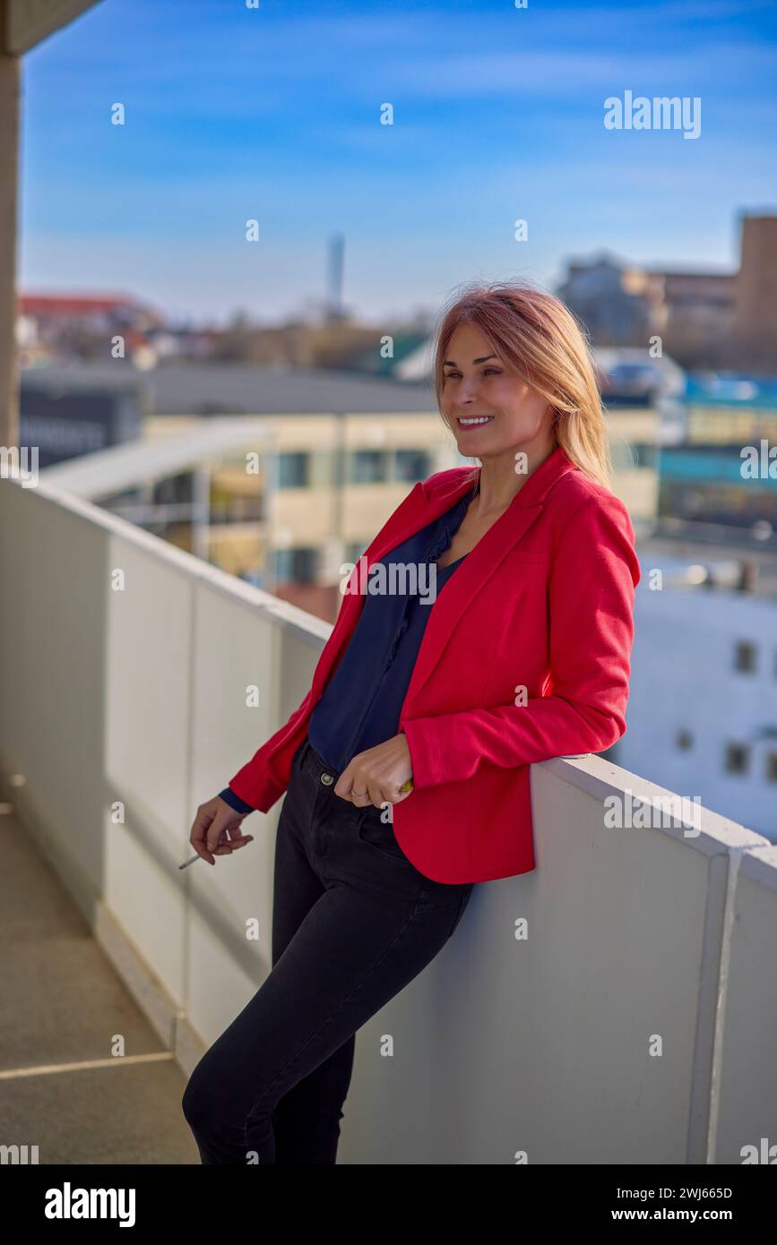 Woman smoking on balcony hi-res stock photography and images - Alamy