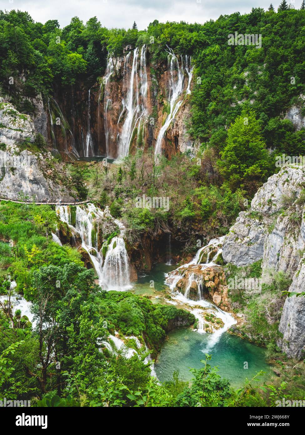 The beautiful waterfalls surrounded by lush greenery in Plitvice Lakes ...