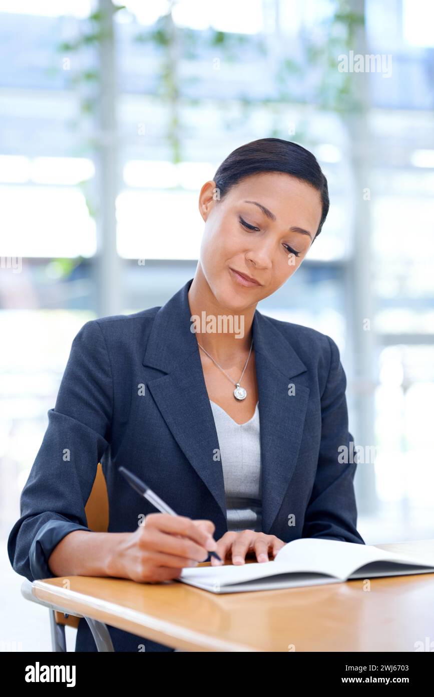 Receptionist, business woman and writing in notebook, agenda or ...