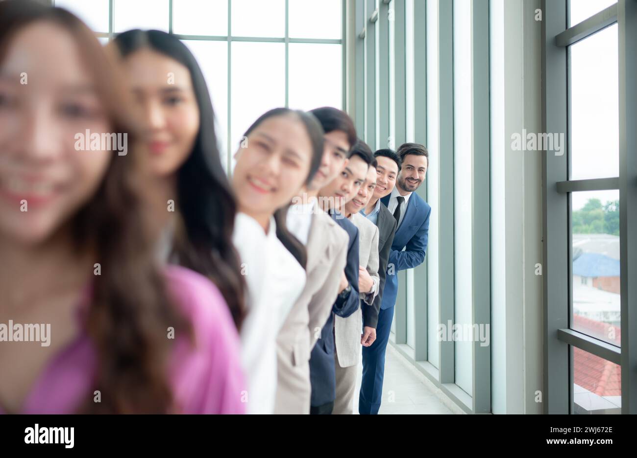 Group of business people standing in line in conference room used for ...