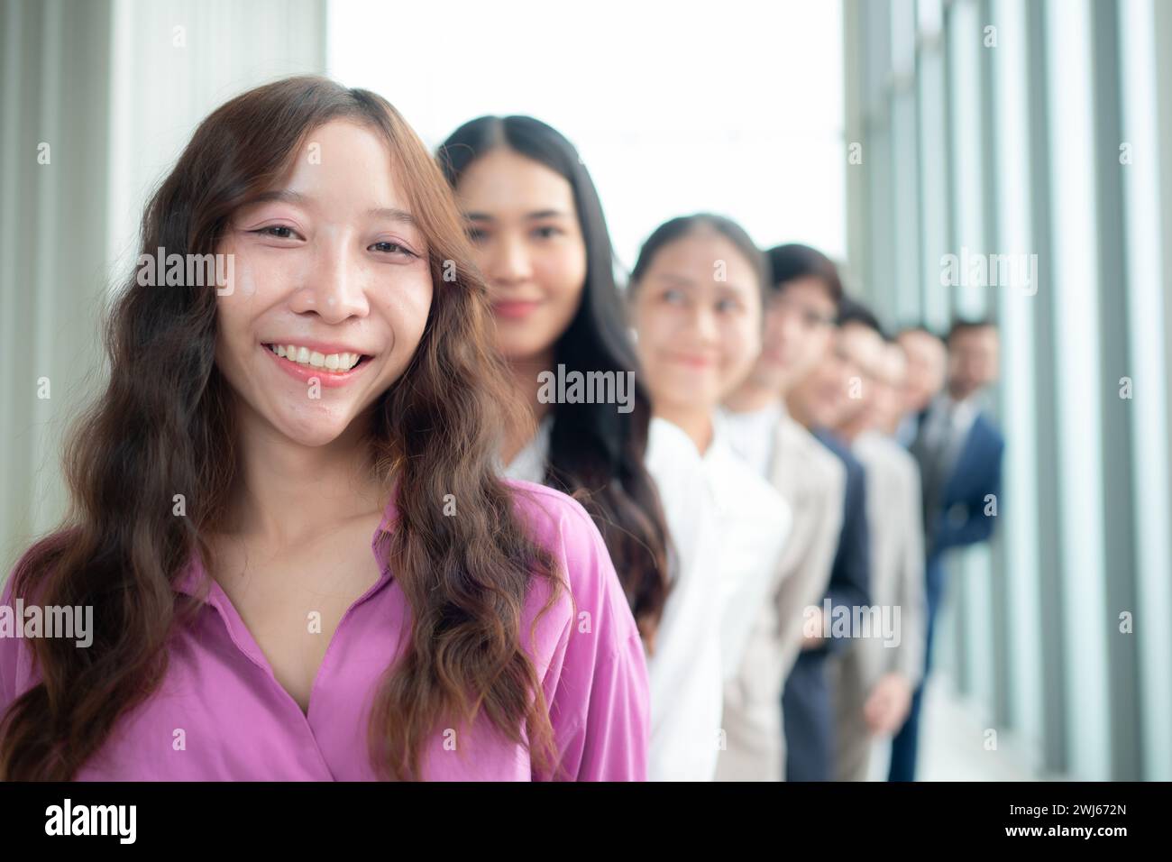 Group of business people standing in line in conference room used for ...