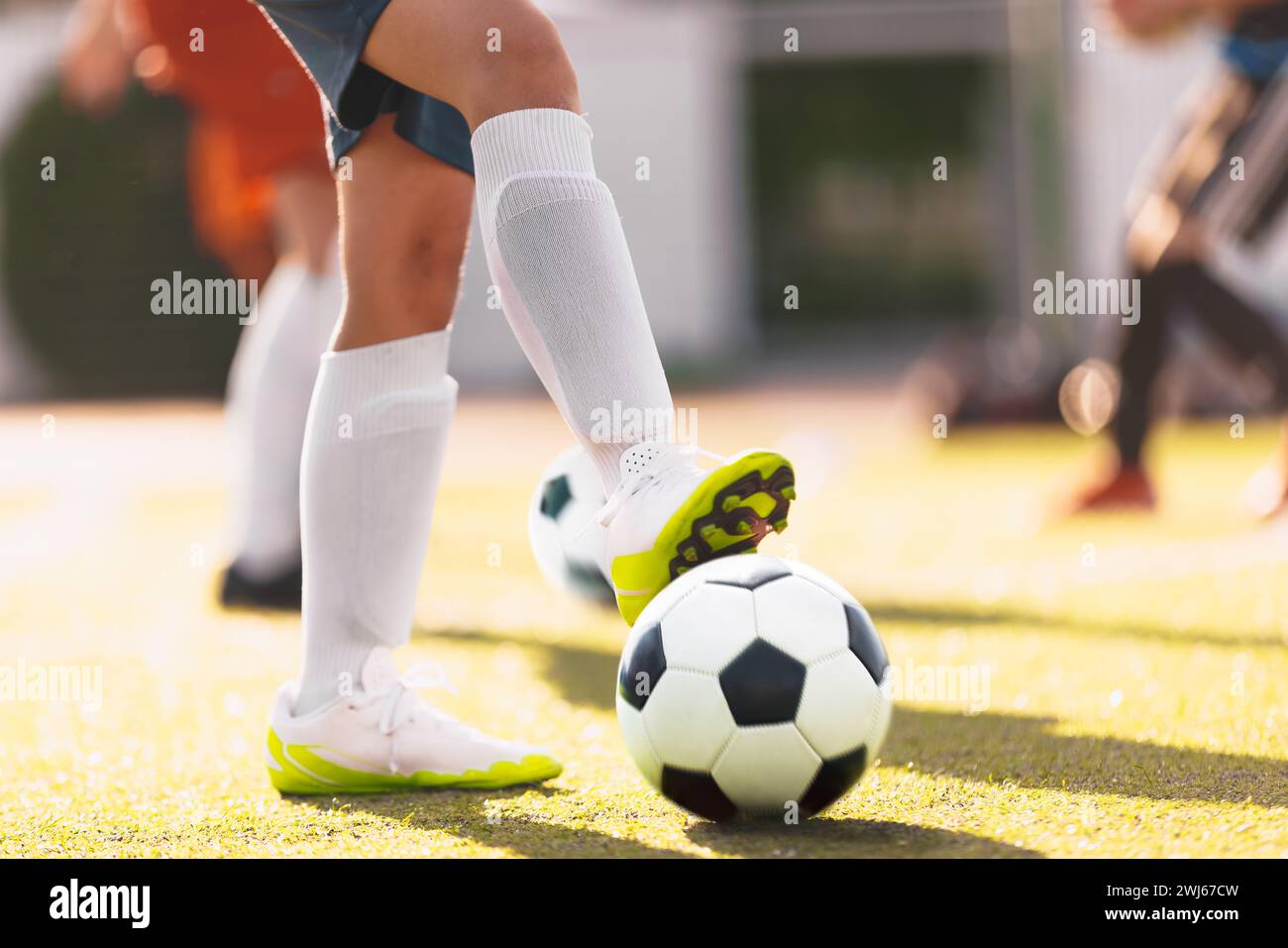 Soccer player practicing dribbling with friends in a team. Group of ...