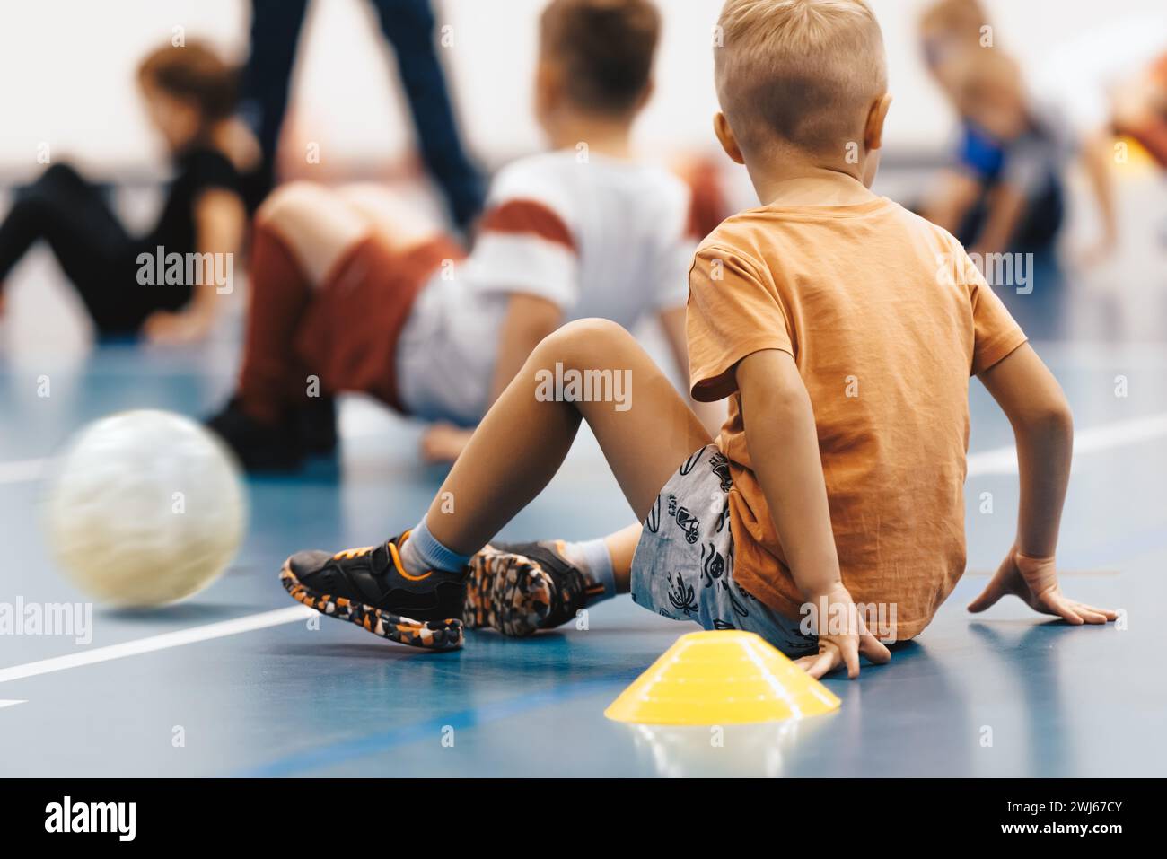 Children in physical education class at school. Group of little boys ...
