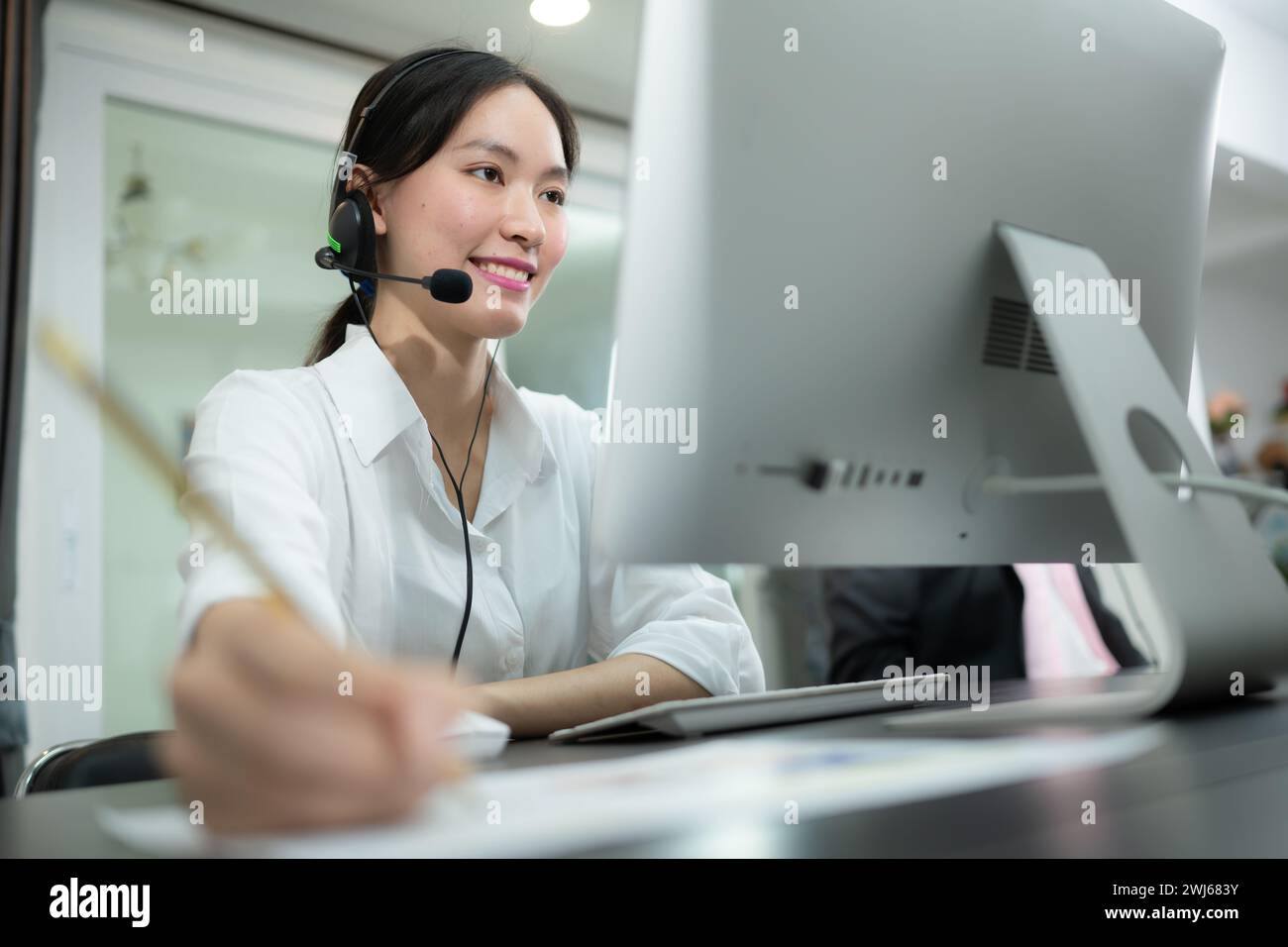Portrait of business people wearing headset working actively in office ...