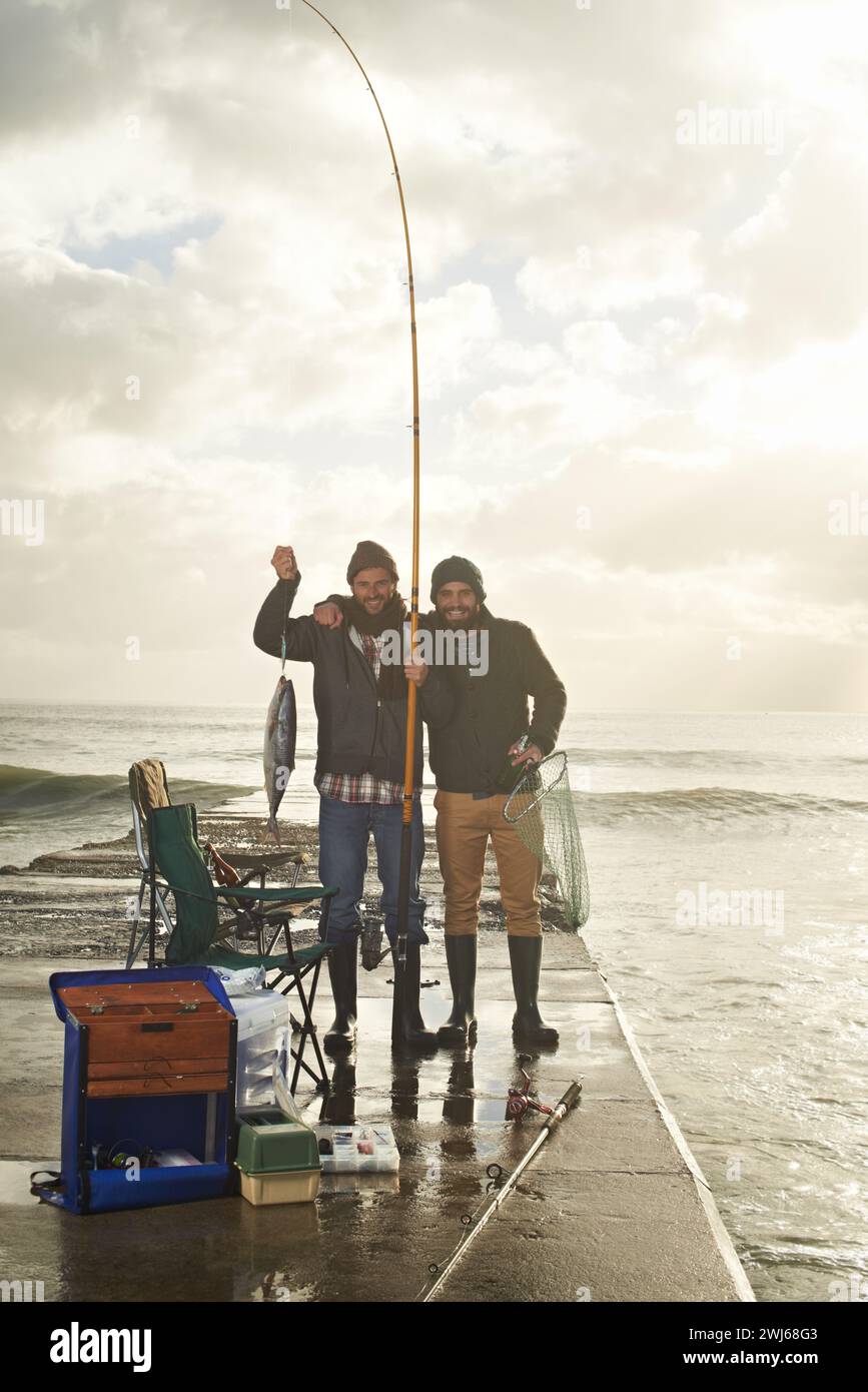 Happy, portrait and people at ocean fishing with pride to catch tuna on ...