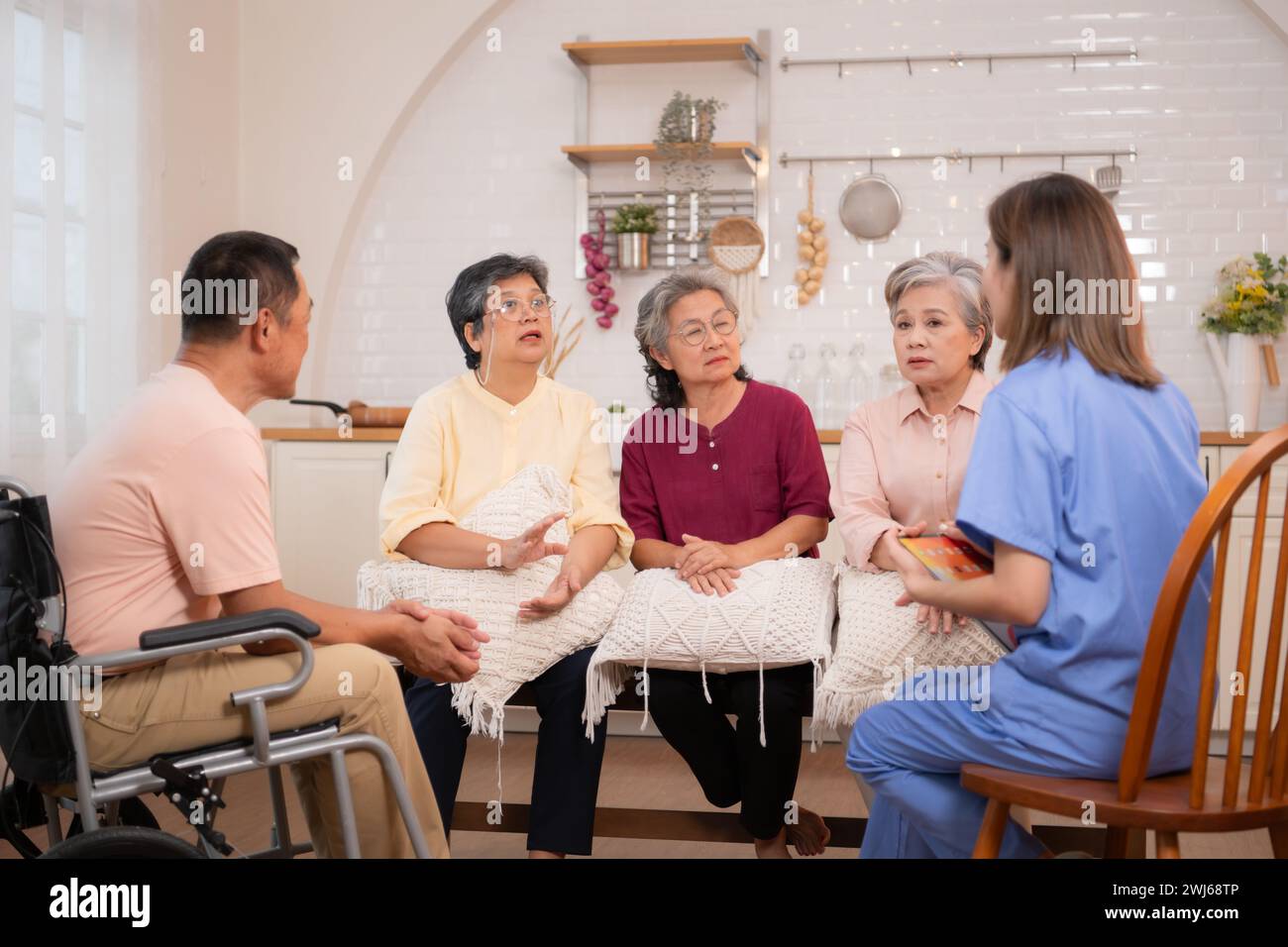 Elderly people talking with nurse in nursing home. Elderly people in ...