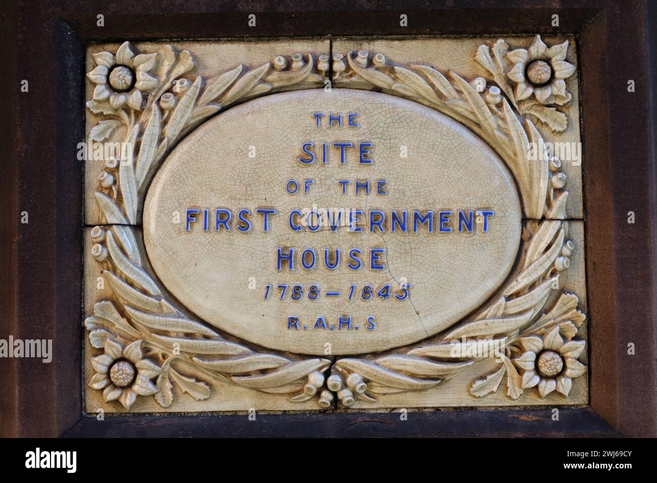 Glazed ceramic plaque with floral emblems in each corner commemorating ...