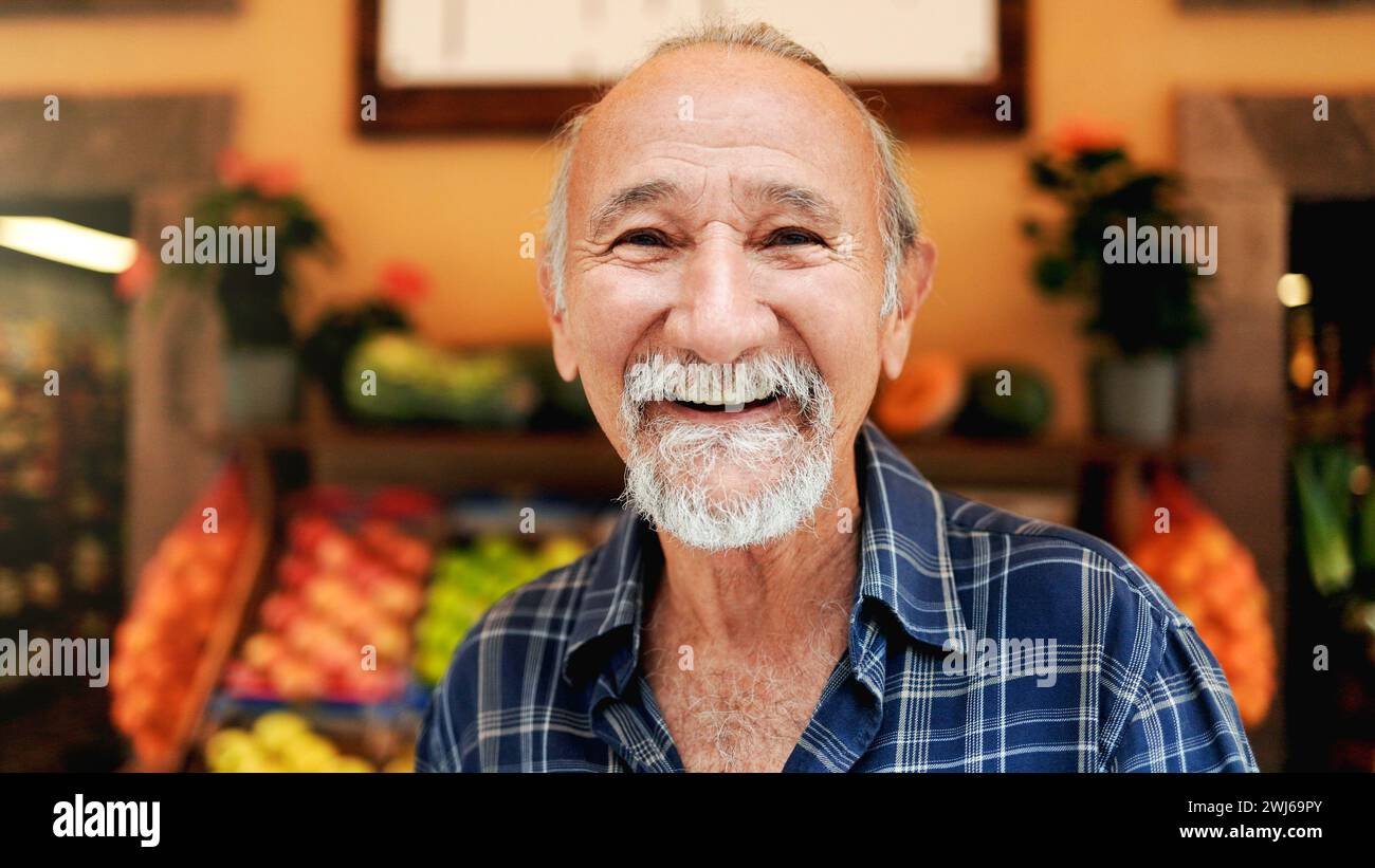 Latin senior man shopping at farm market. Customer buying at grocery ...