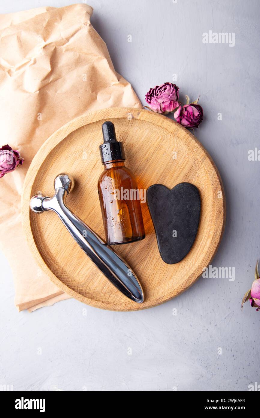 Self care composition with facial serum, gua sha, facial roller ...