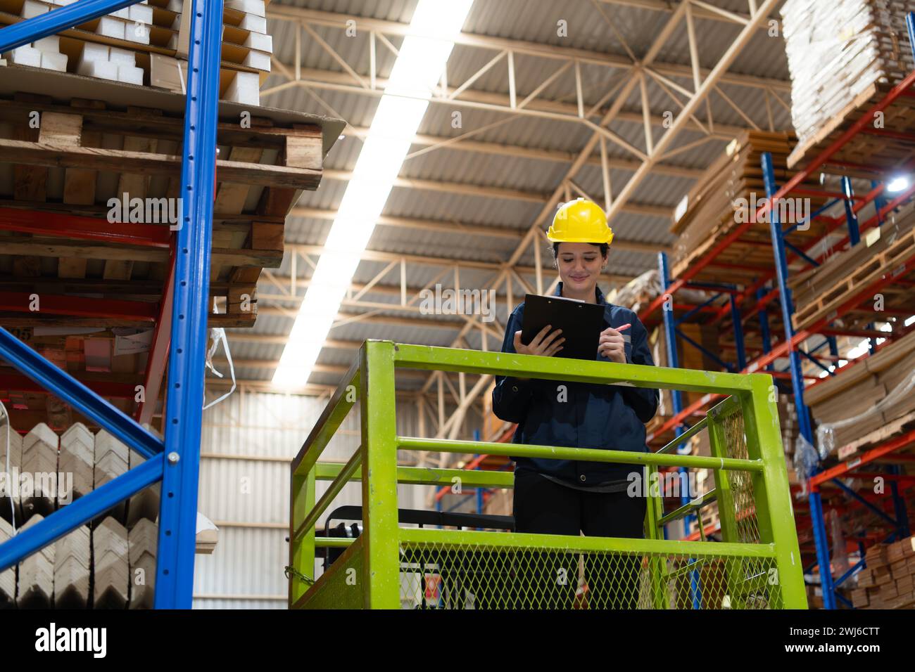 Warehouse workers using forklift to check and counting in a large ...