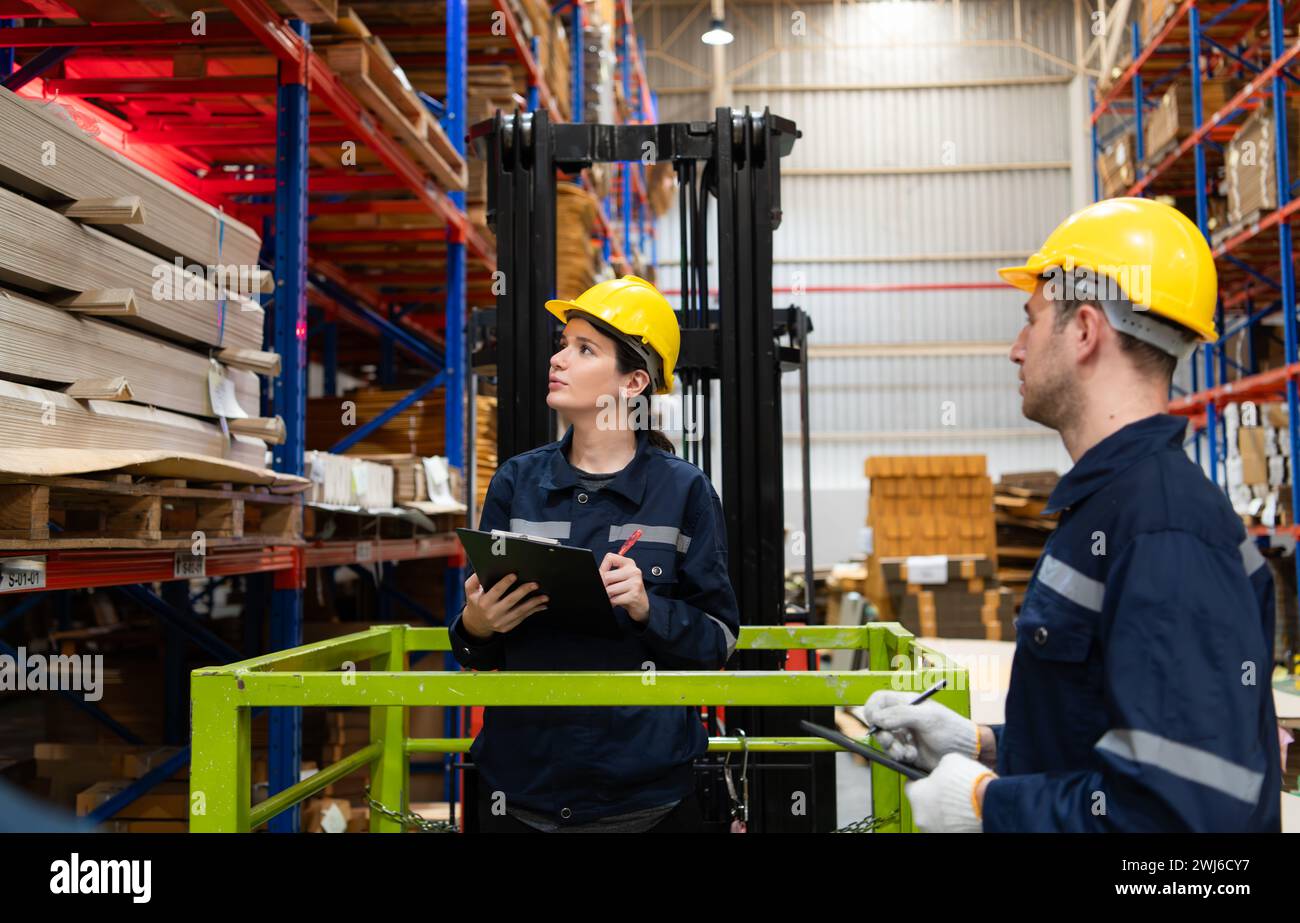 Warehouse workers using forklift to check and counting in a large ...