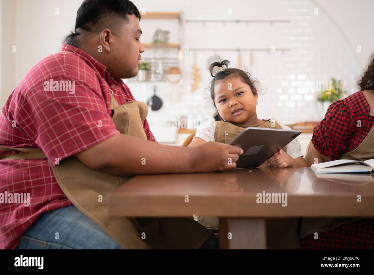 A plus-size family with a father wearing a prosthetic leg, is happily ...