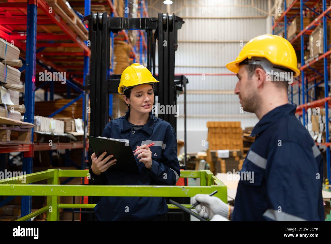 Warehouse workers using forklift to check and counting in a large ...