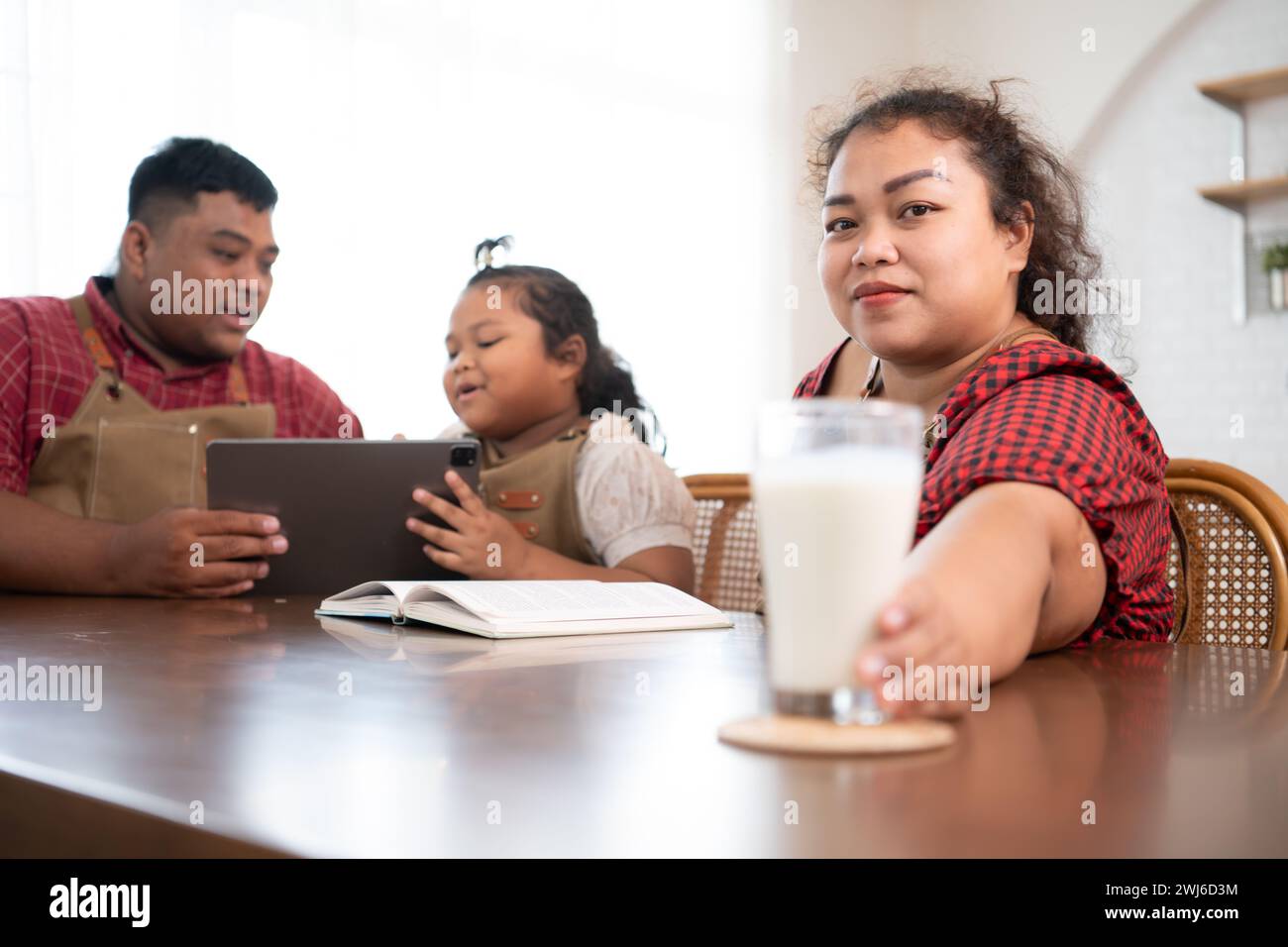 A plus-size family with a father wearing a prosthetic leg, is happily ...