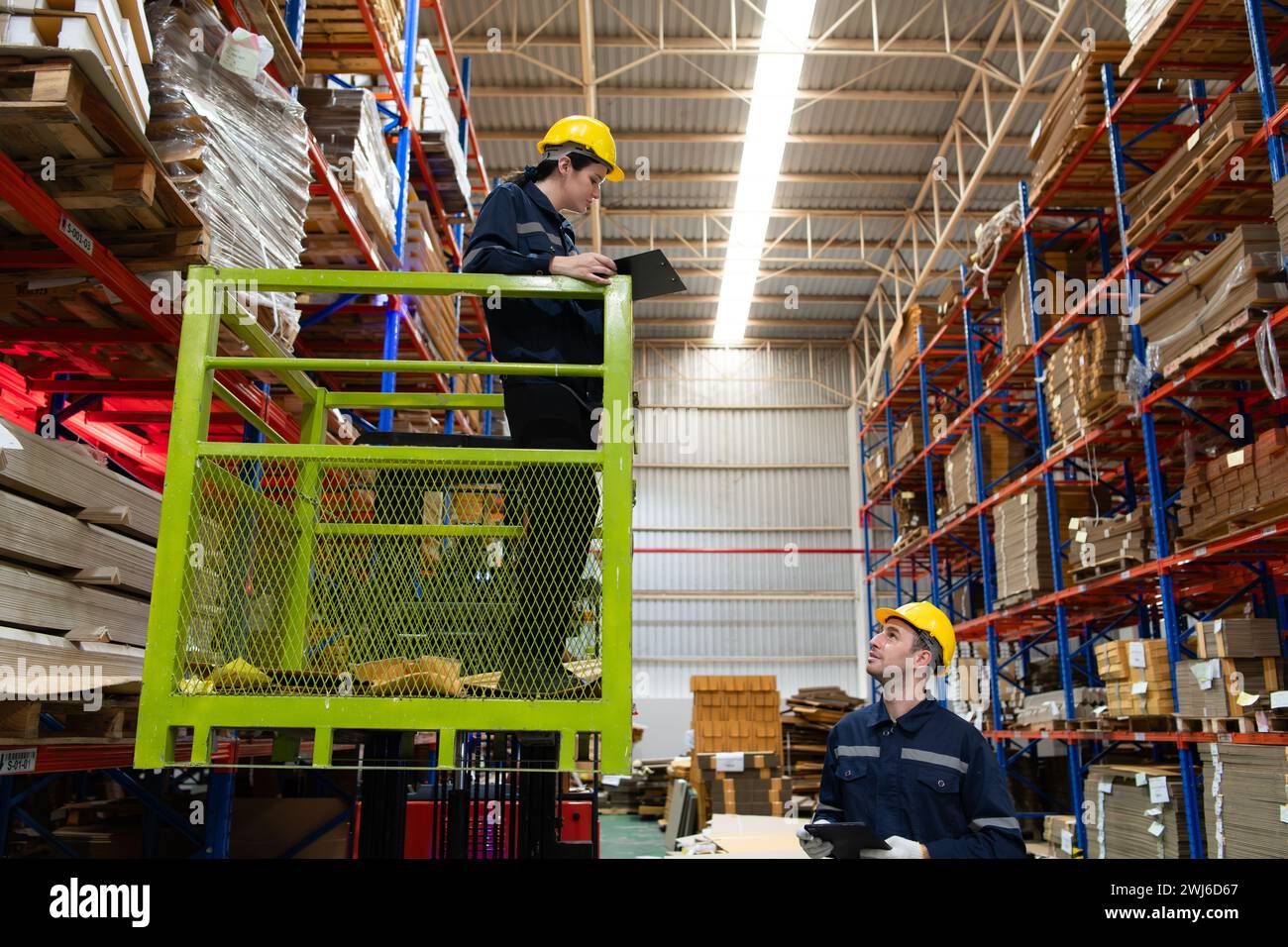 Warehouse workers using forklift to check and counting in a large ...