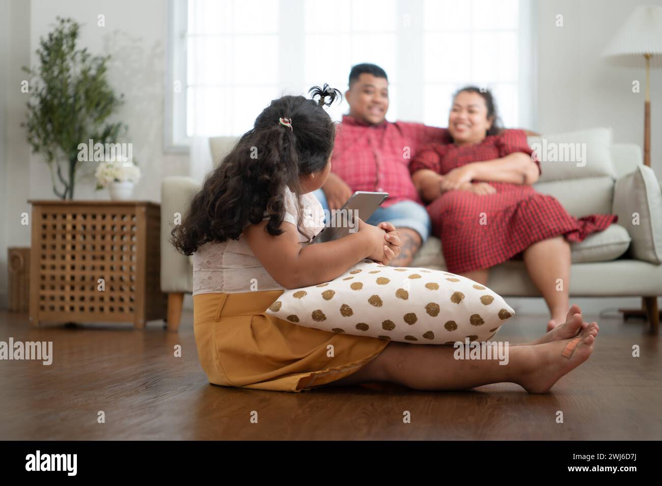 A plus size family with a father wearing a prosthetic leg, During rest ...