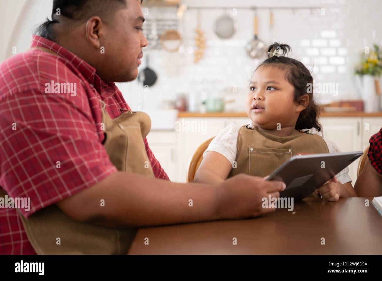 A plus-size family with a father wearing a prosthetic leg, is happily ...