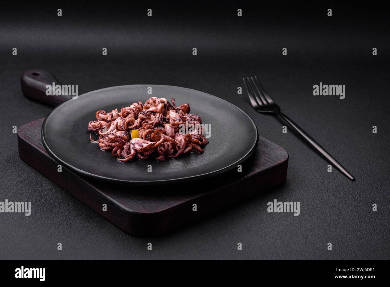 Delicious marinated octopus babies with lemon, salt and spices Stock ...