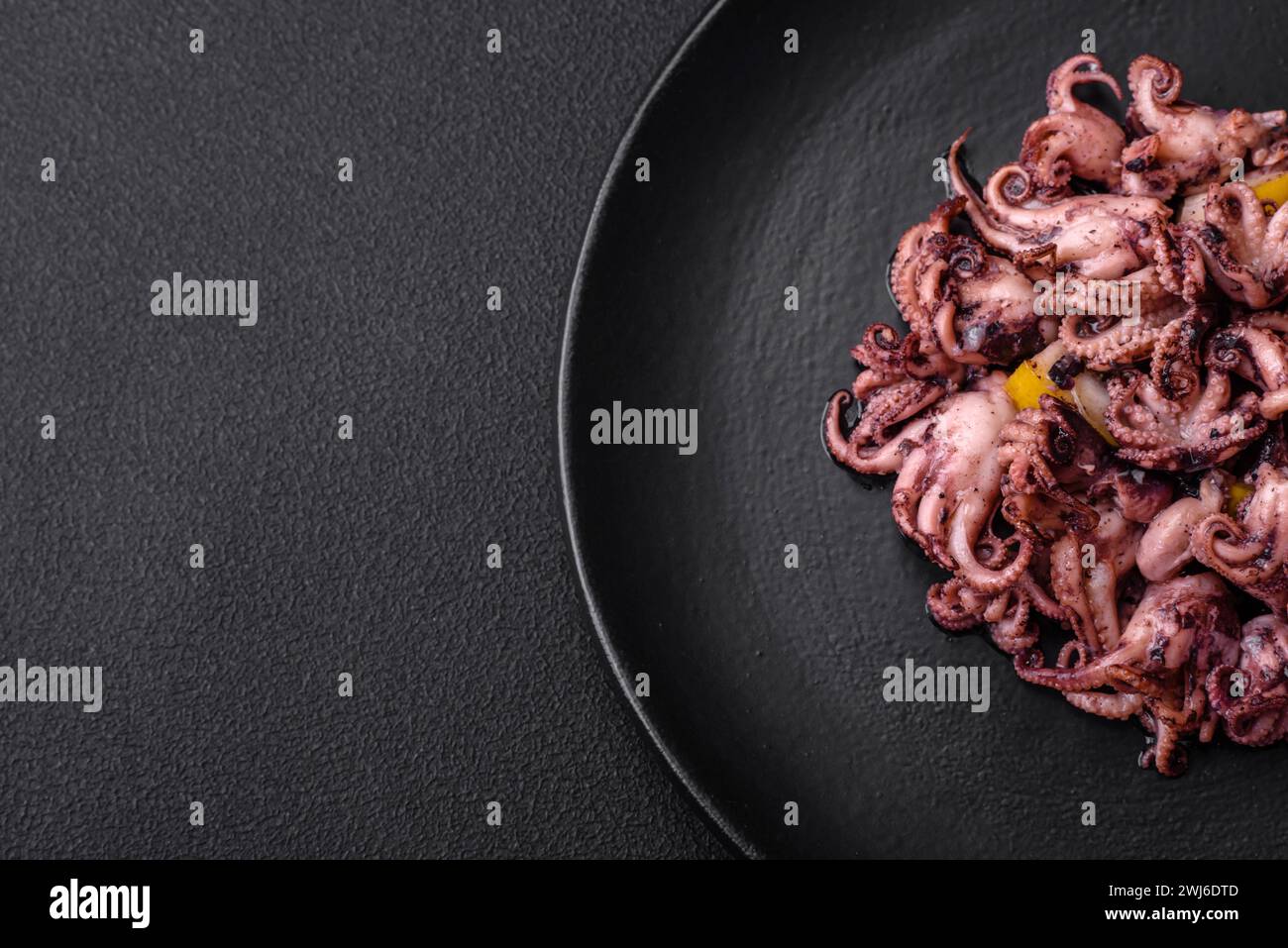 Delicious marinated octopus babies with lemon, salt and spices Stock ...