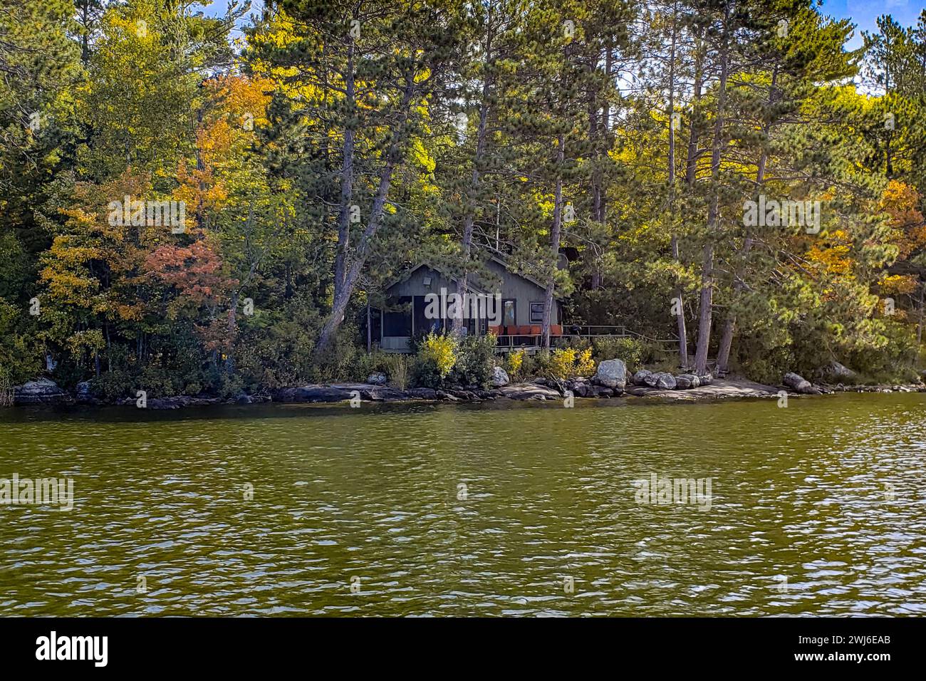 A scenic view of Lake Vermilion with a rustic cabin hidden behind trees ...