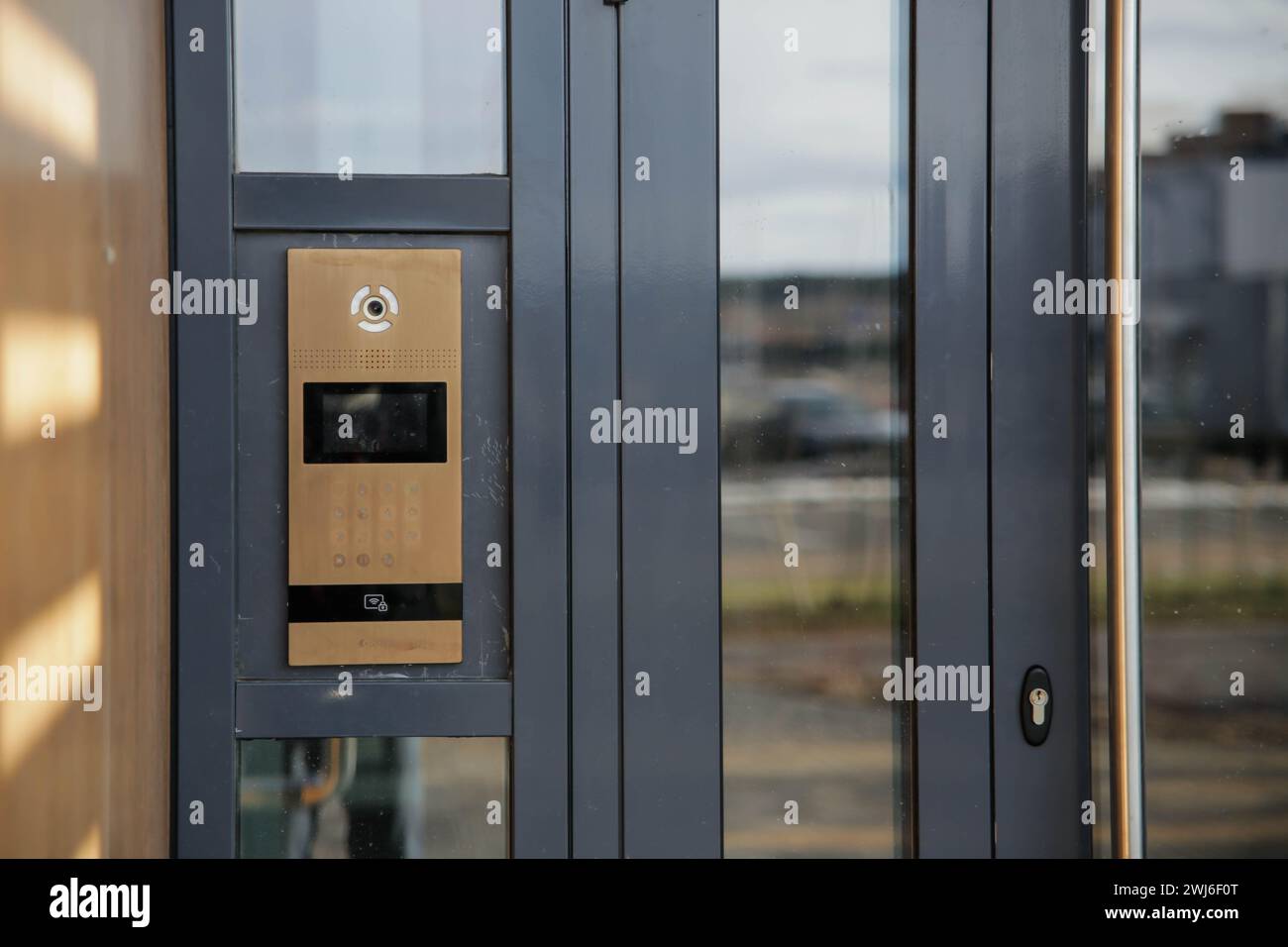 Modern golden entrance doorbell intercom in apartment building, with a ...
