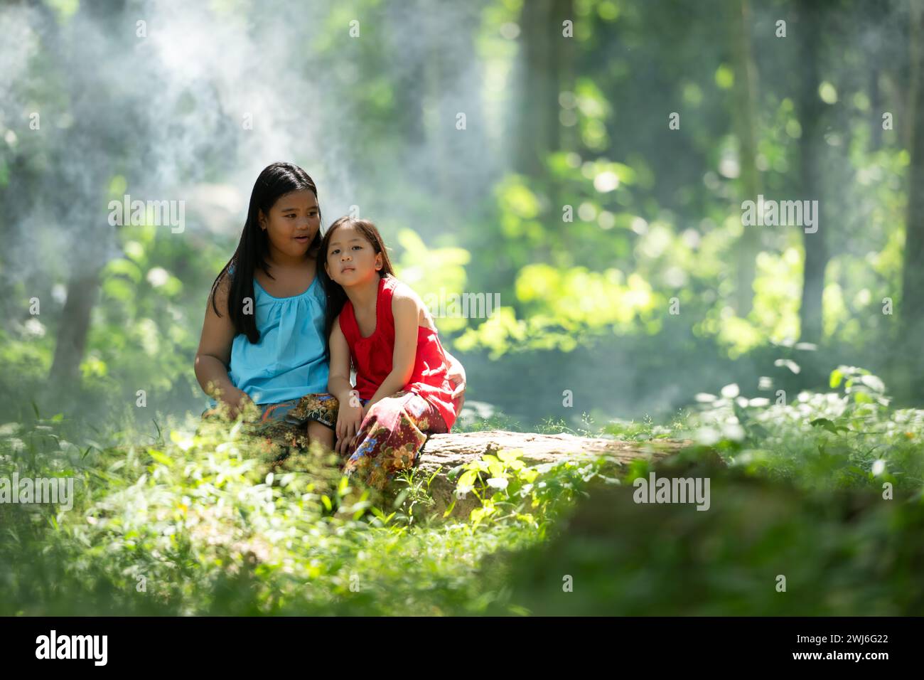 Two girls Asian women with traditional clothing stand had fun playing ...