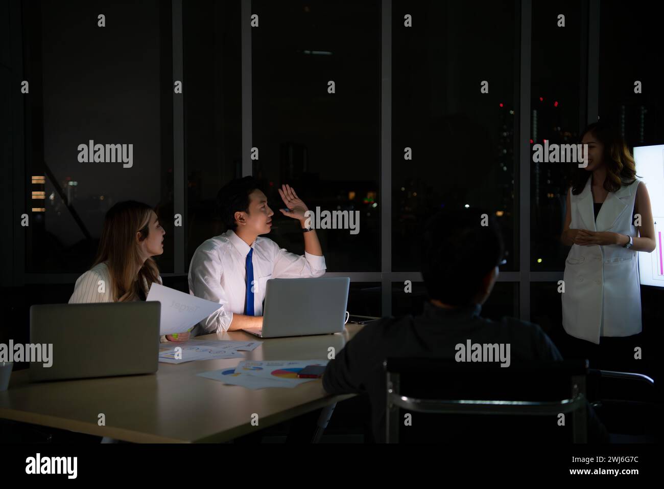 Group of broker international stock traders working actively at night ...