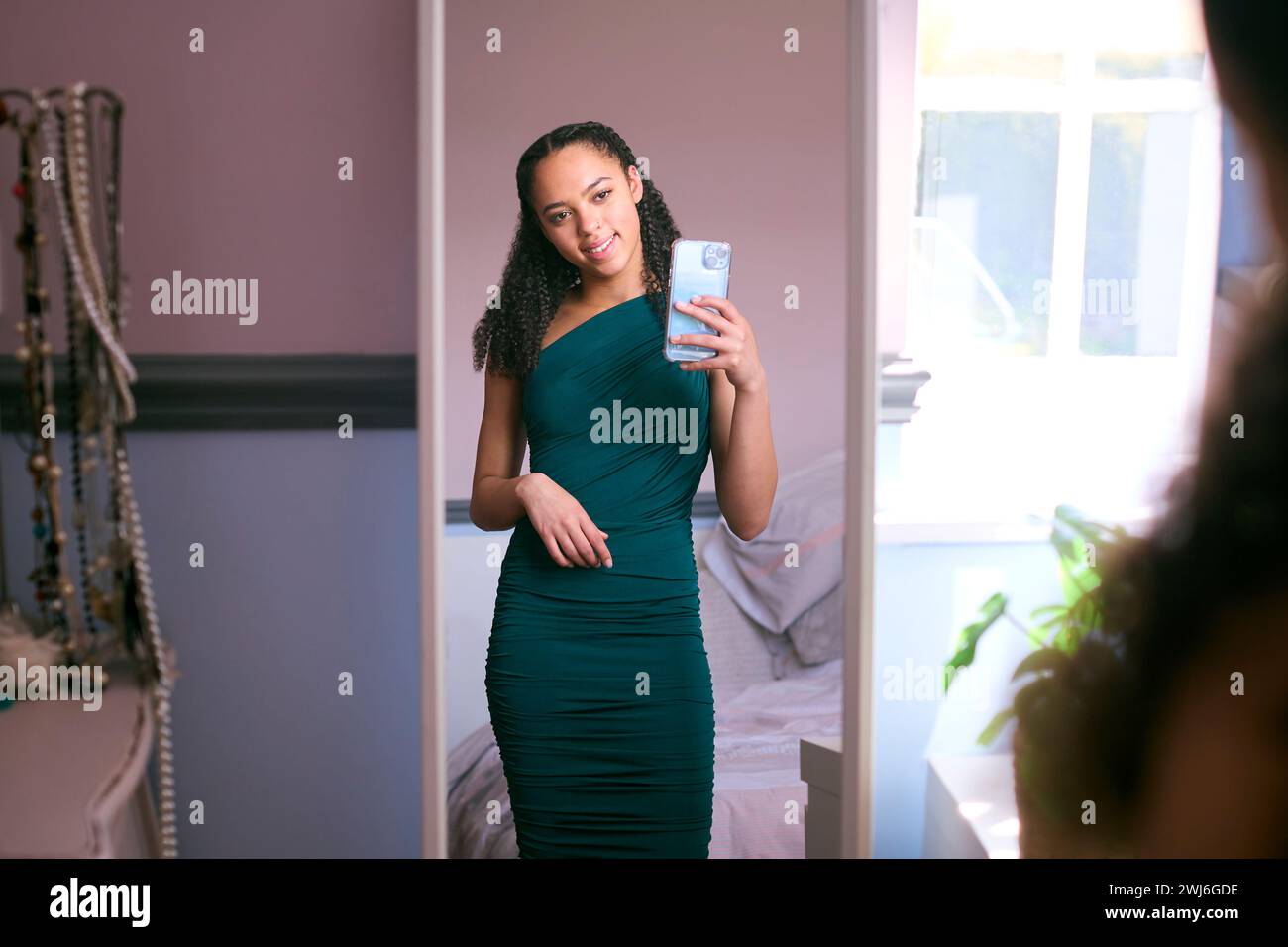 Teenage Girl At Home In Bedroom Getting Ready For Prom Or Night Out ...