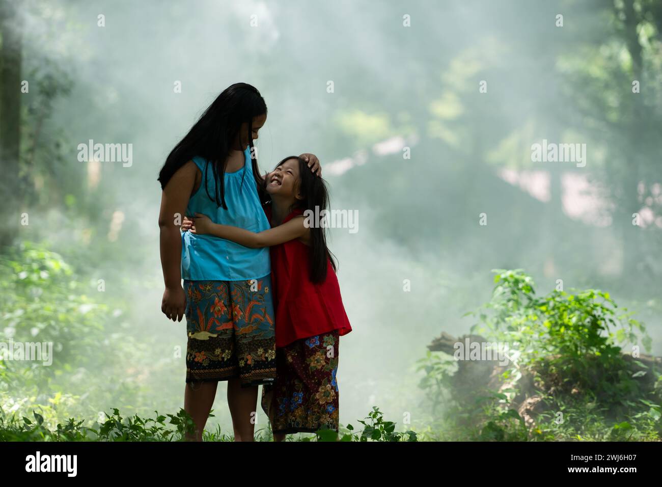 Two girls Asian women with traditional clothing stand had fun playing ...
