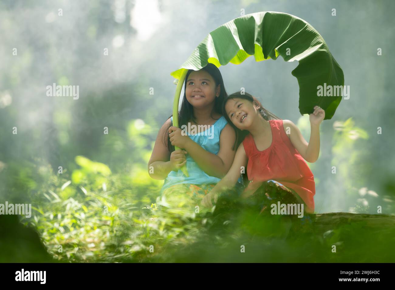 Two girls Asian women with traditional clothing stand had fun playing ...