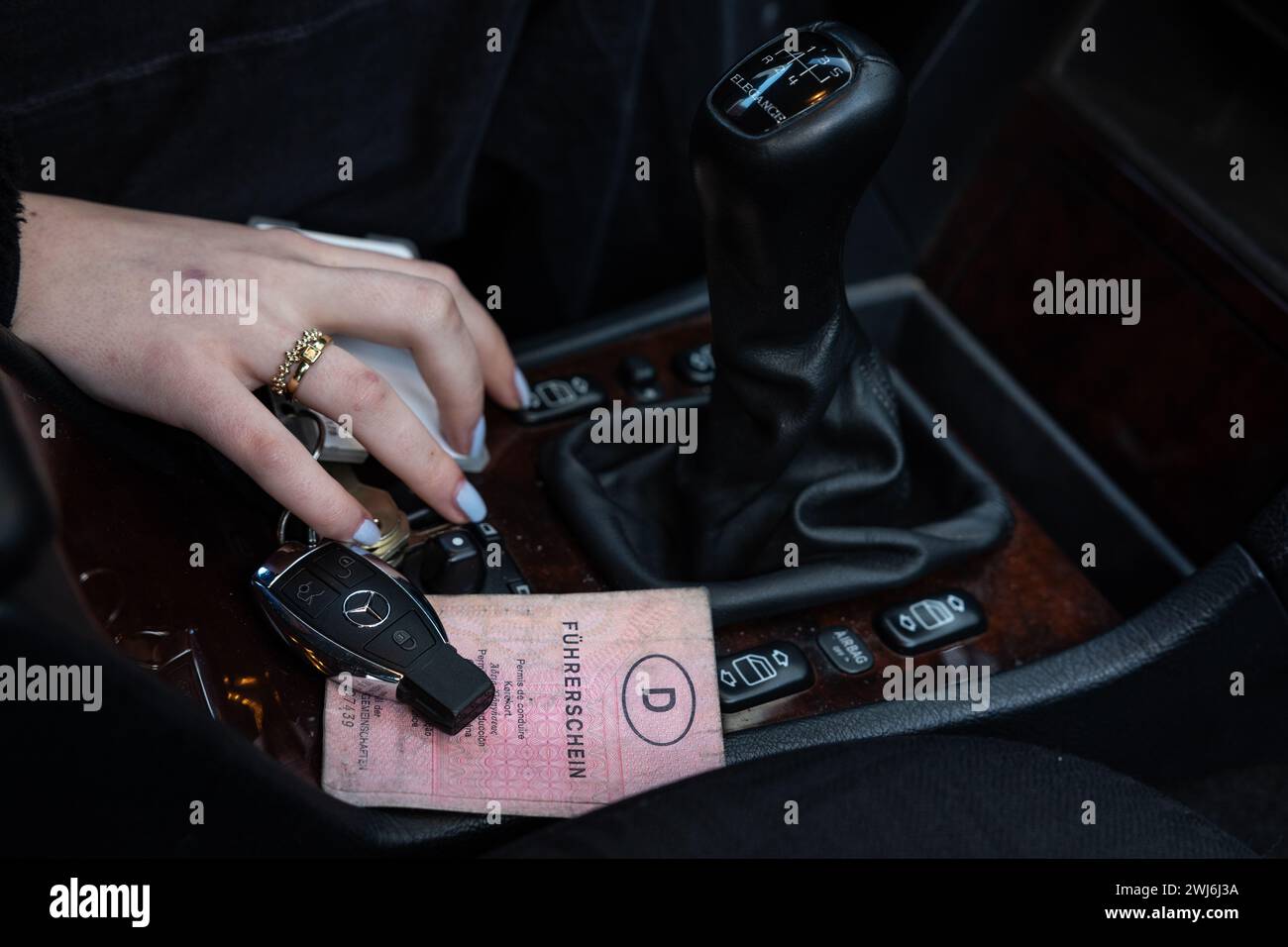 Berlin, Germany. 13th Feb, 2024. A woman reaches for a paper driver's ...