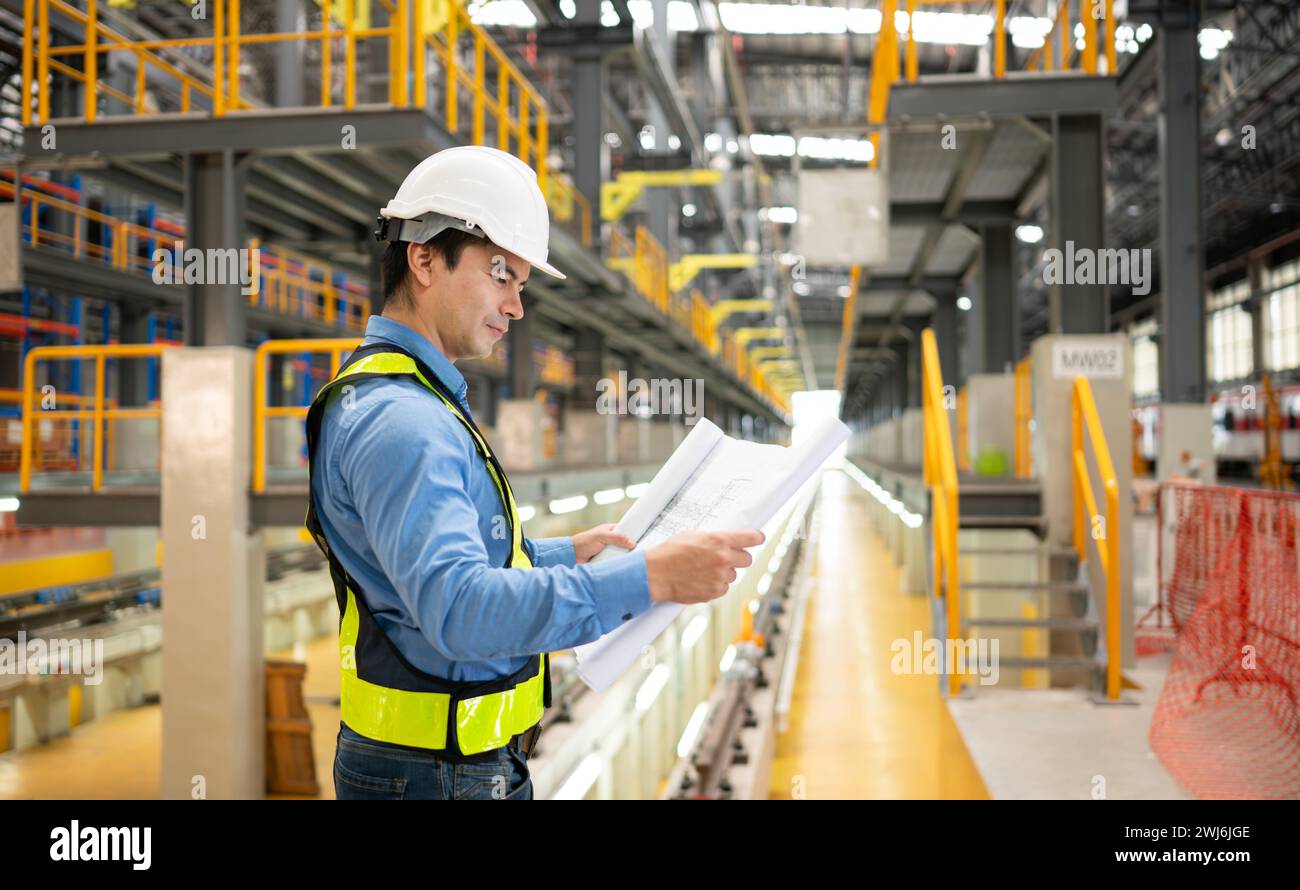 Electric vehicle engineer with blueprints prepare to inspect electric ...