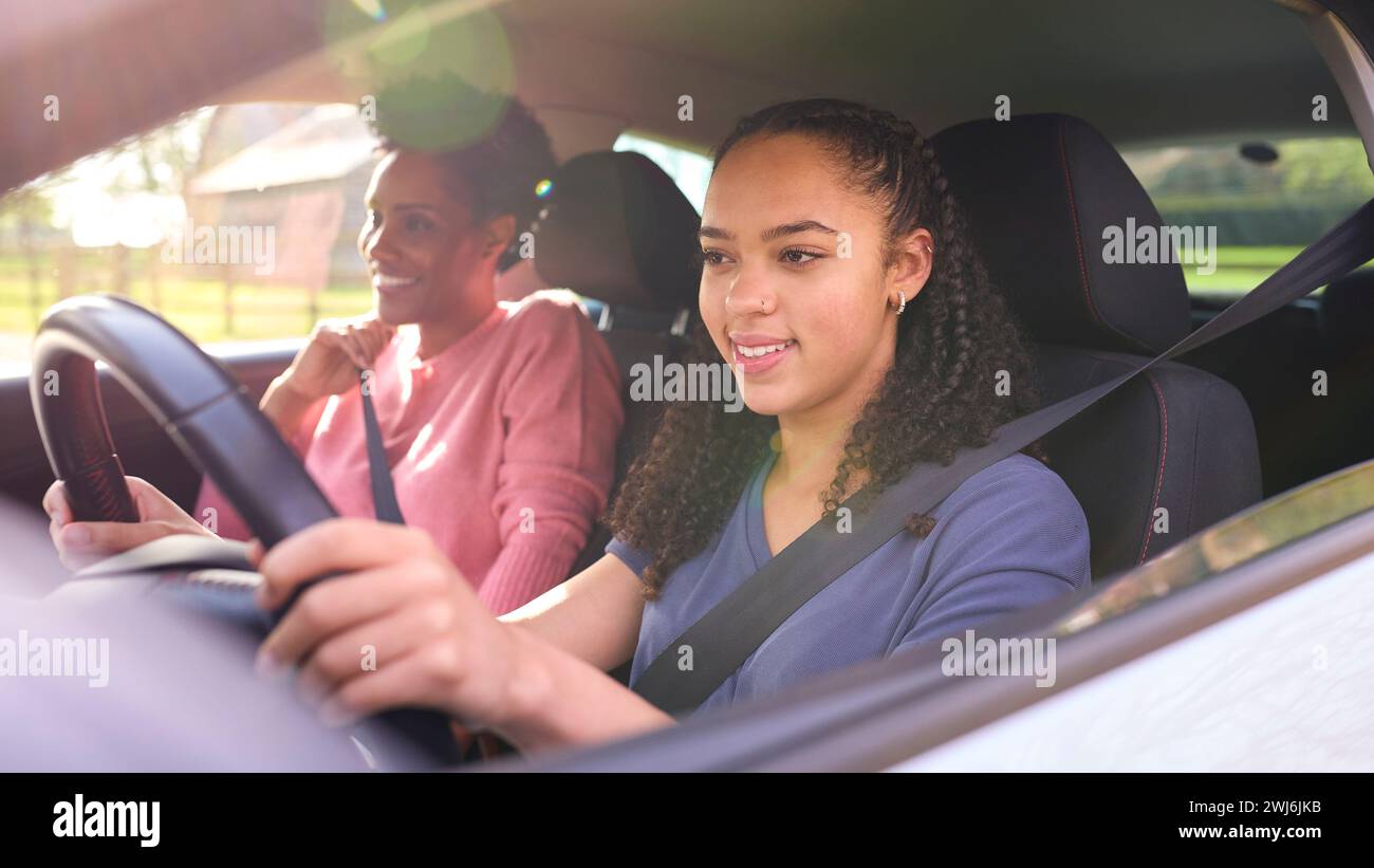Teenage Girl In Car Having Driving Lesson From Female Instructor Or ...