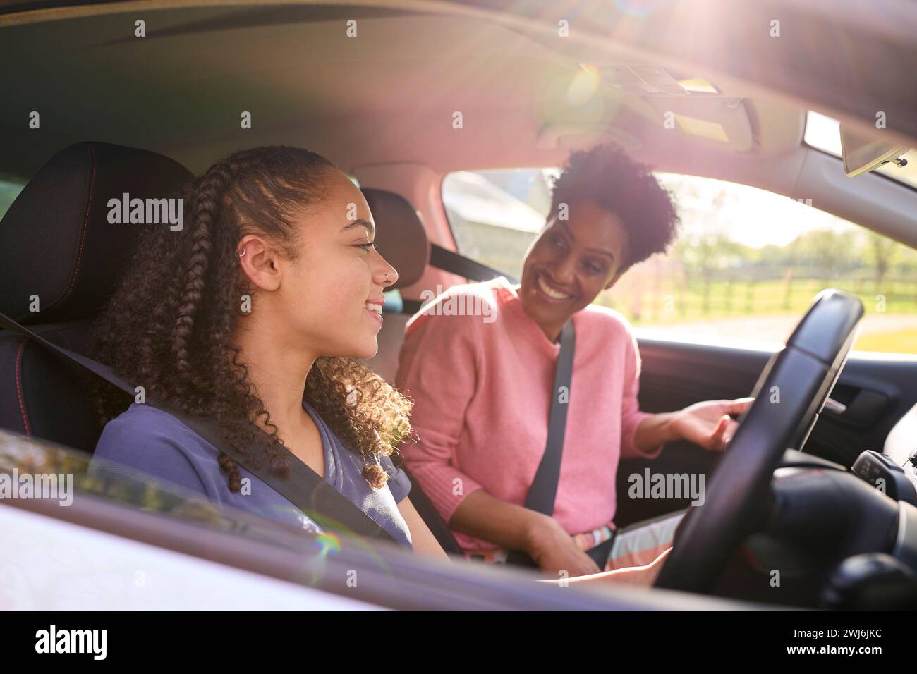 Teenage Girl In Car Having Driving Lesson From Female Instructor Or ...