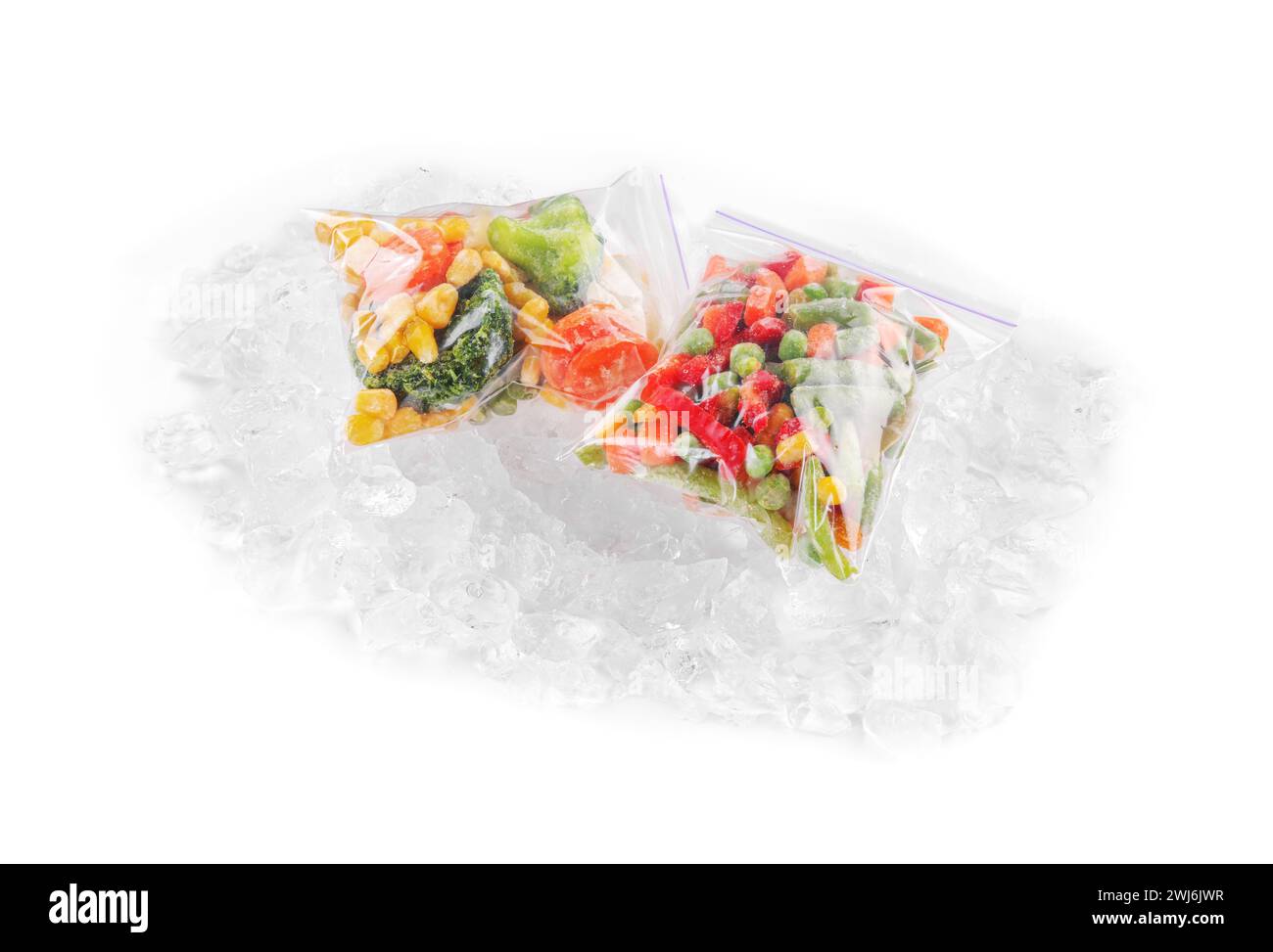 Bags of different frozen vegetables and ice isolated on white Stock ...