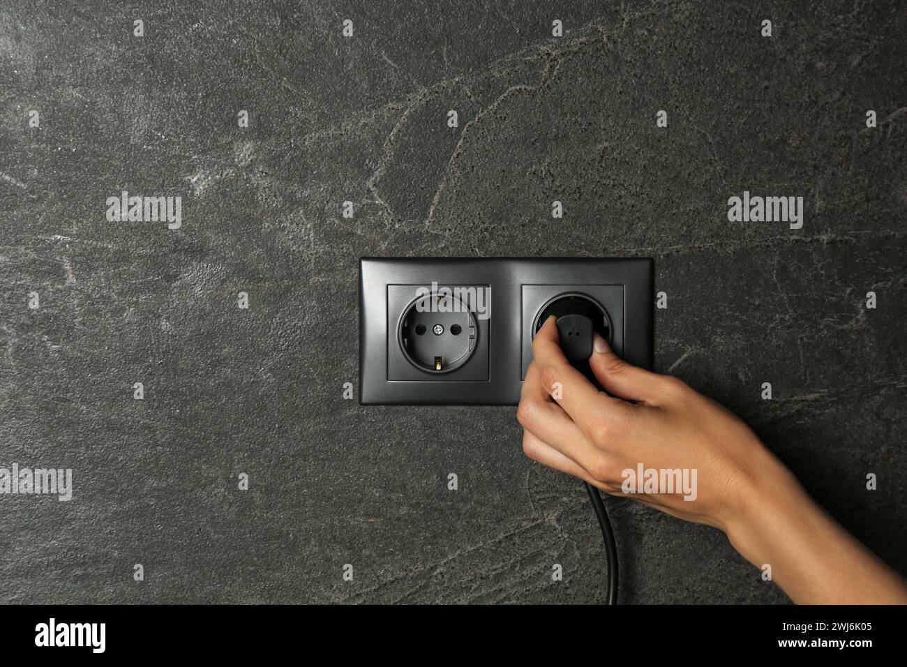 Hand putting plug electricity socket hi-res stock photography and ...