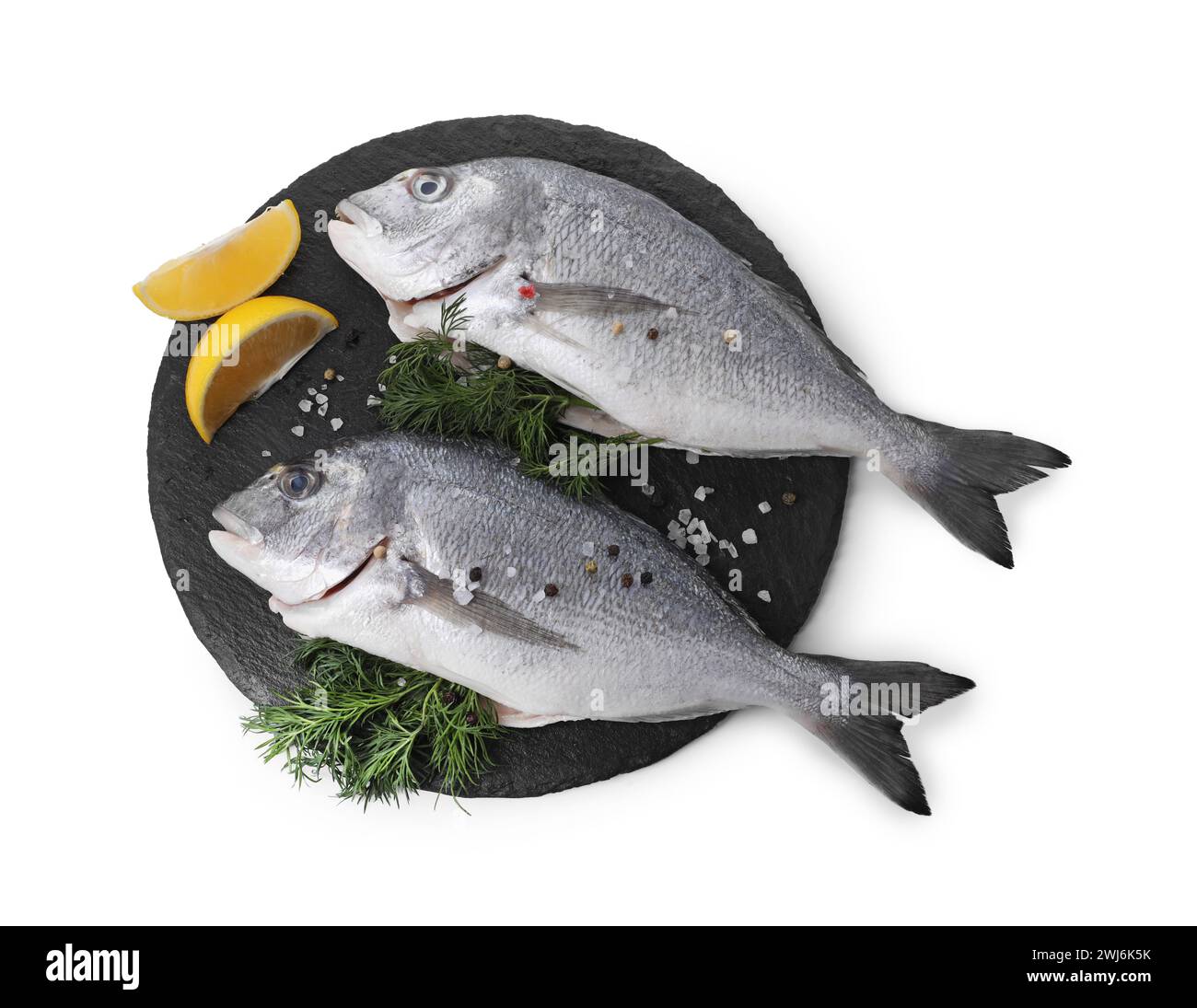 Raw dorado fish, dill, lemon wedges and peppercorns isolated on white ...
