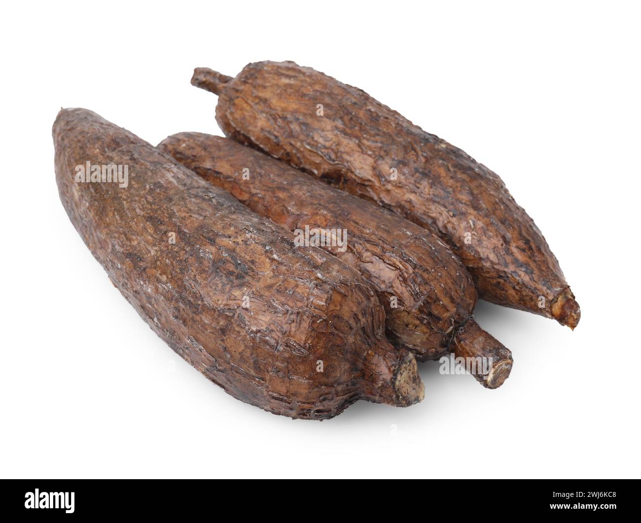 Three whole ripe cassava roots isolated on white Stock Photo - Alamy