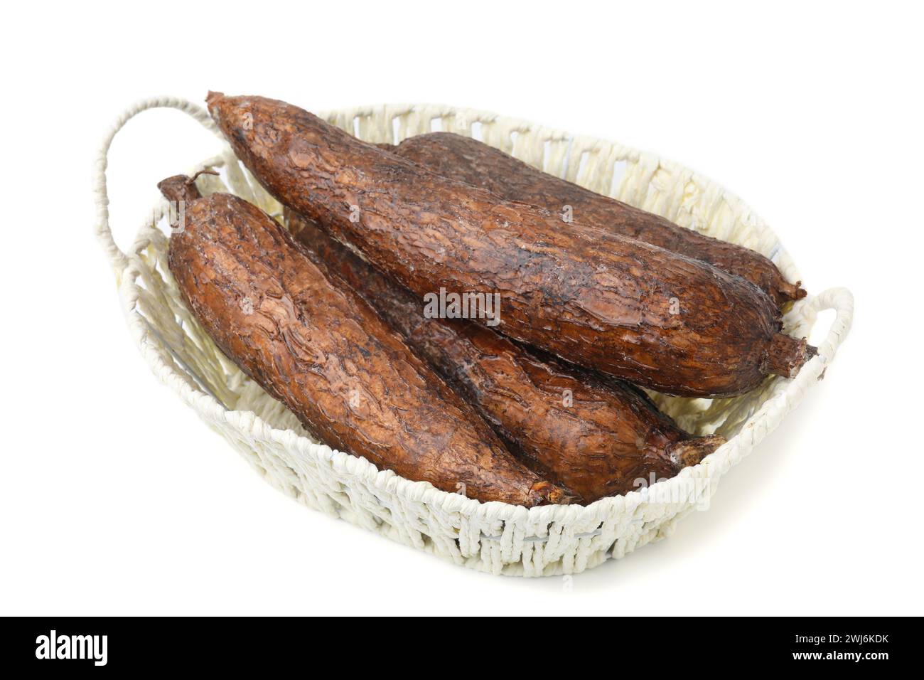 Whole cassava roots in basket isolated on white Stock Photo - Alamy
