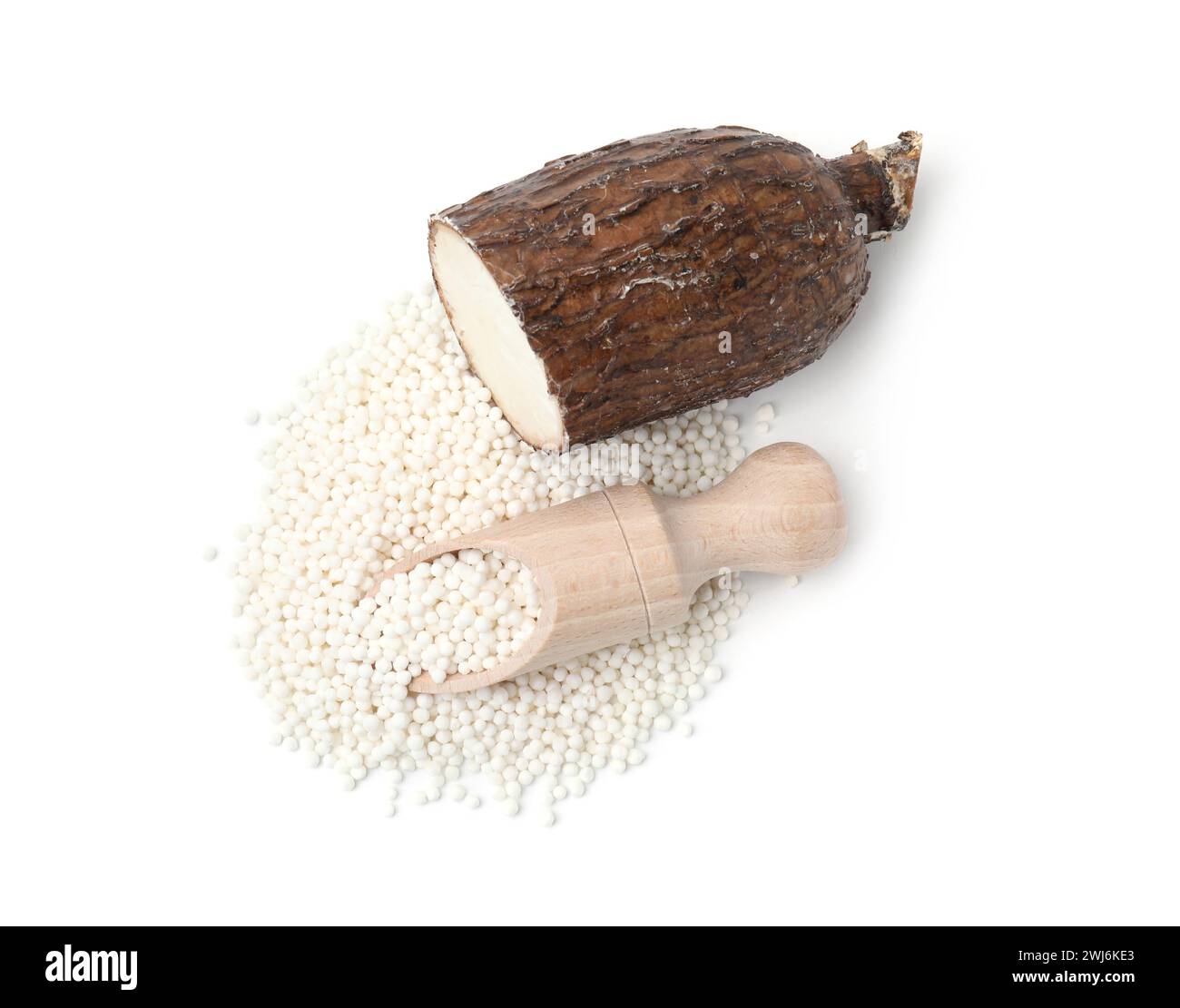 Pile of tapioca pearls, scoop and cassava root isolated on white, top ...