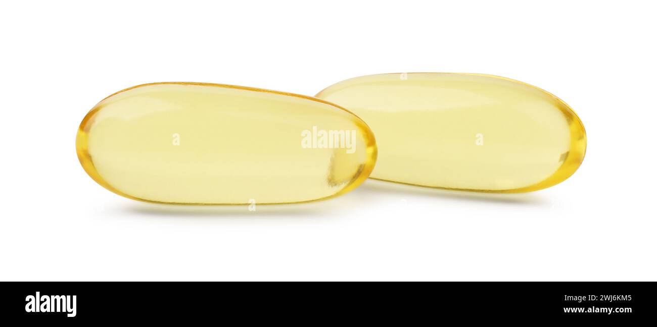Two yellow vitamin capsules isolated on white Stock Photo - Alamy