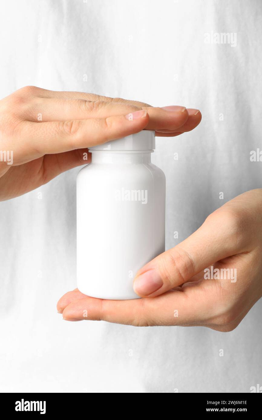 Woman holding one white pill bottle, closeup Stock Photo - Alamy