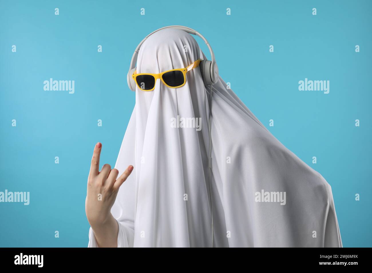 Stylish ghost. Person covered with white sheet in sunglasses and ...